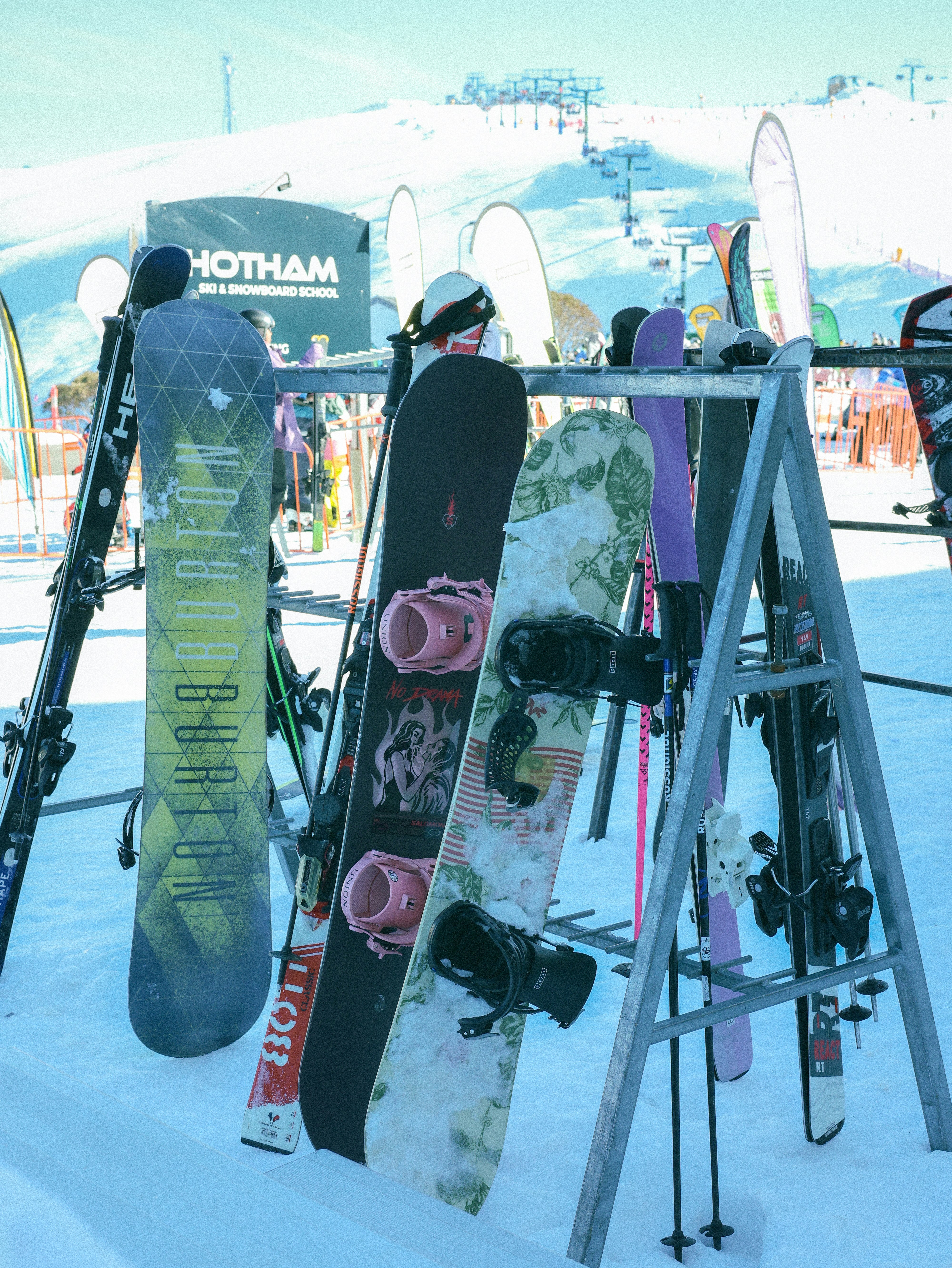 Snowbound Stacks: Snowboards Stand Guard at a Mountain Base
