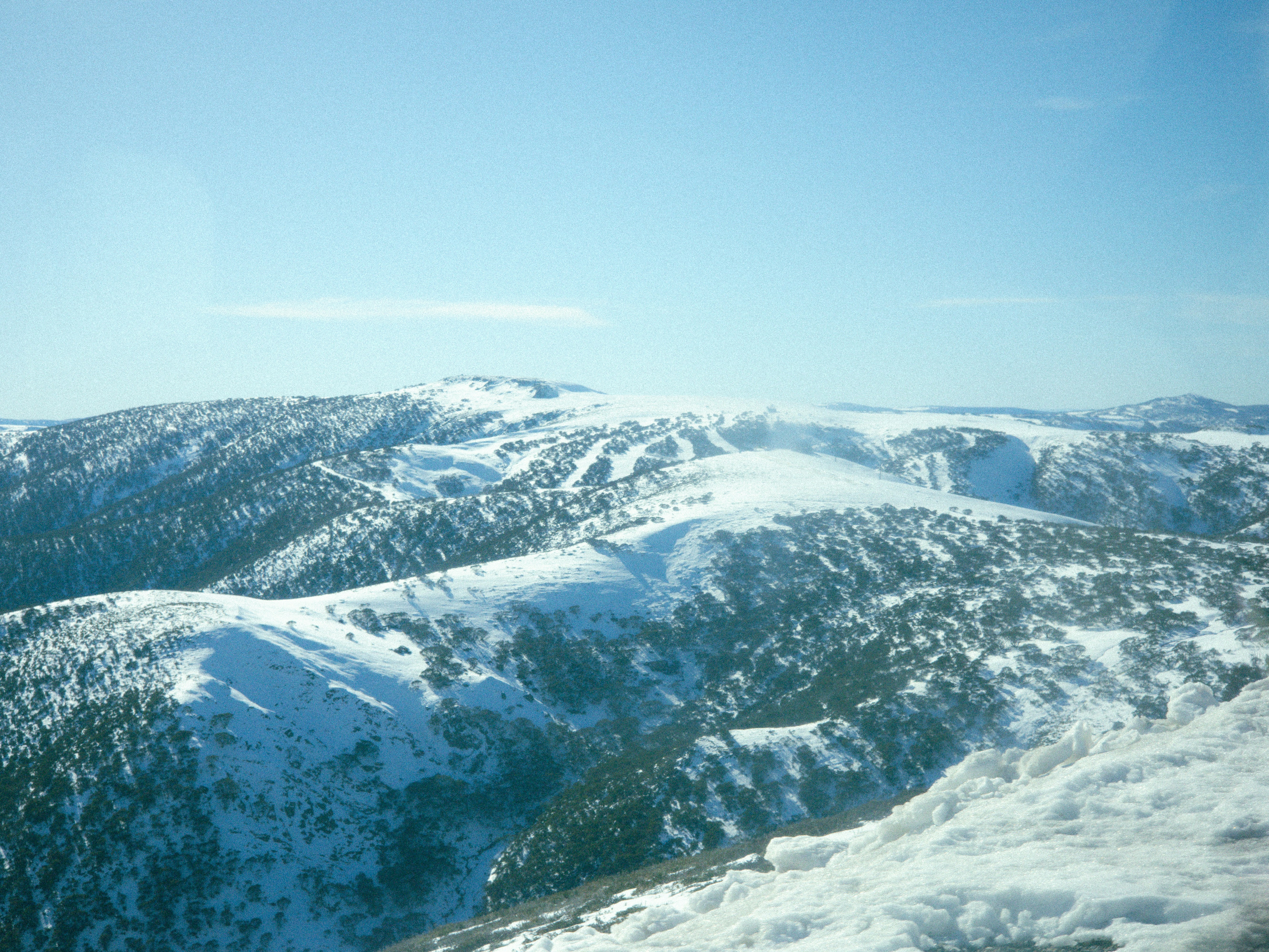 Snow-Capped Horizon: A Quiet Ascent Over Alpine Valleys