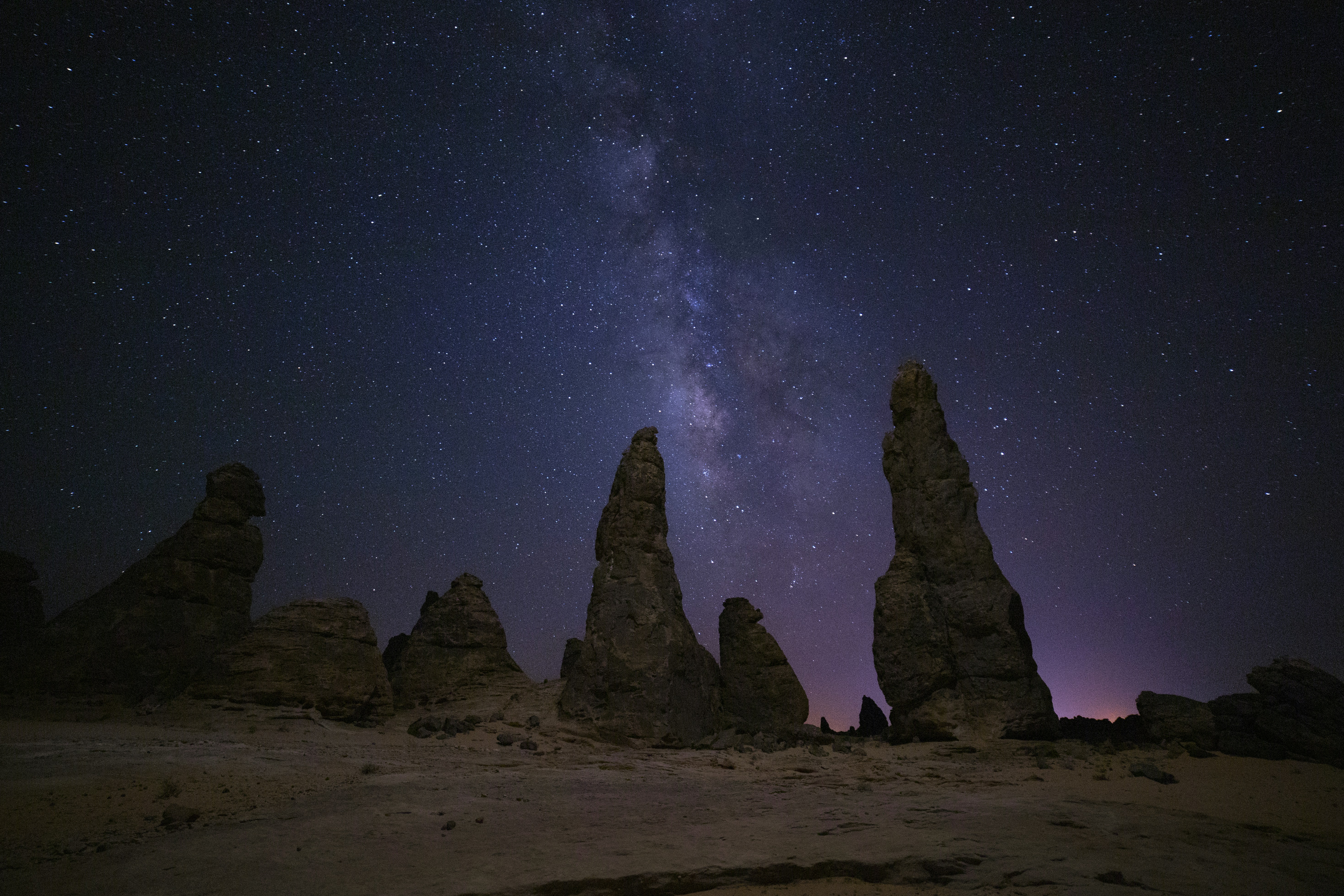 Vertical Monoliths under a Milky Way Arc