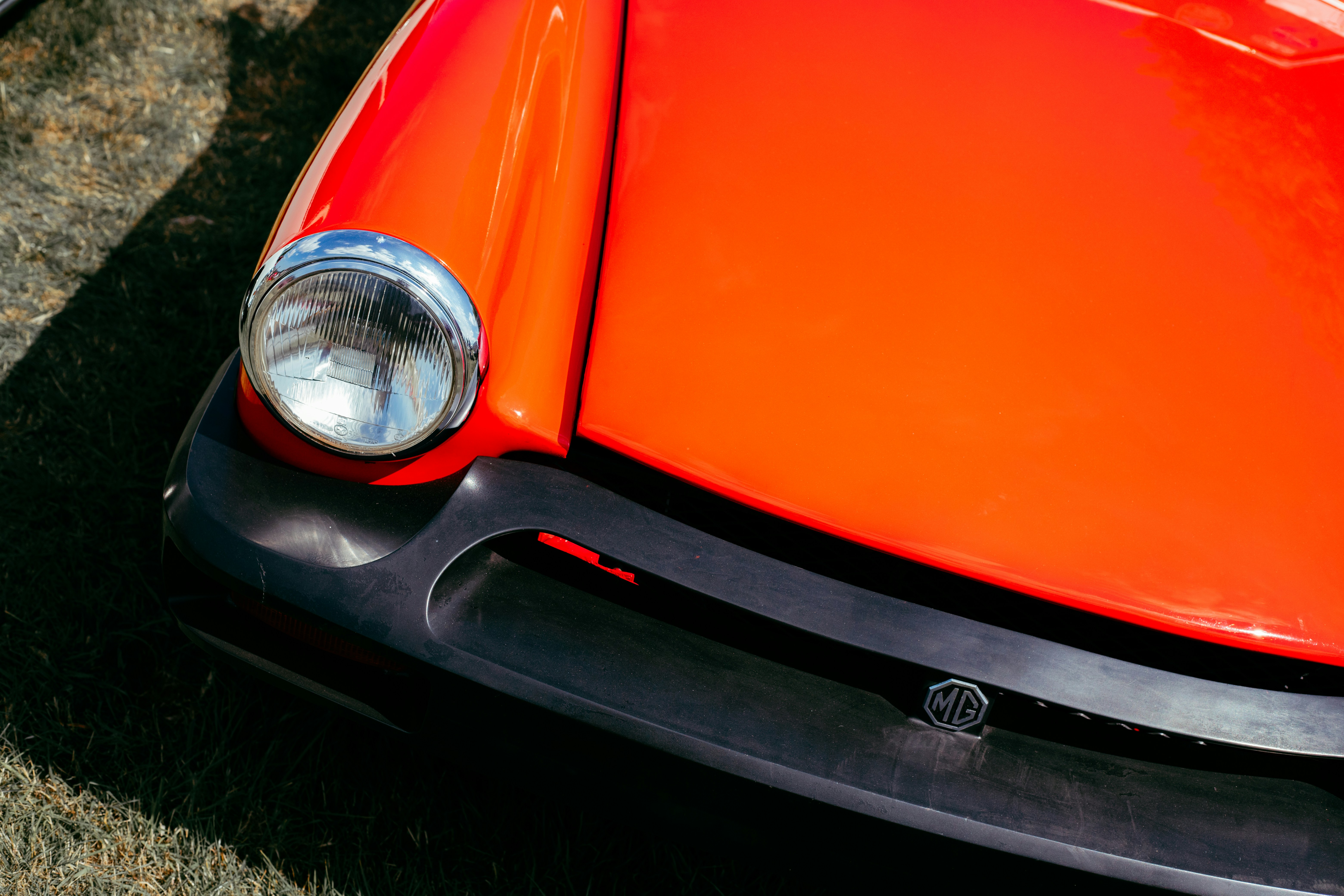 Red Vintage MG Grin: A Curved Hood and Classic Headlamp