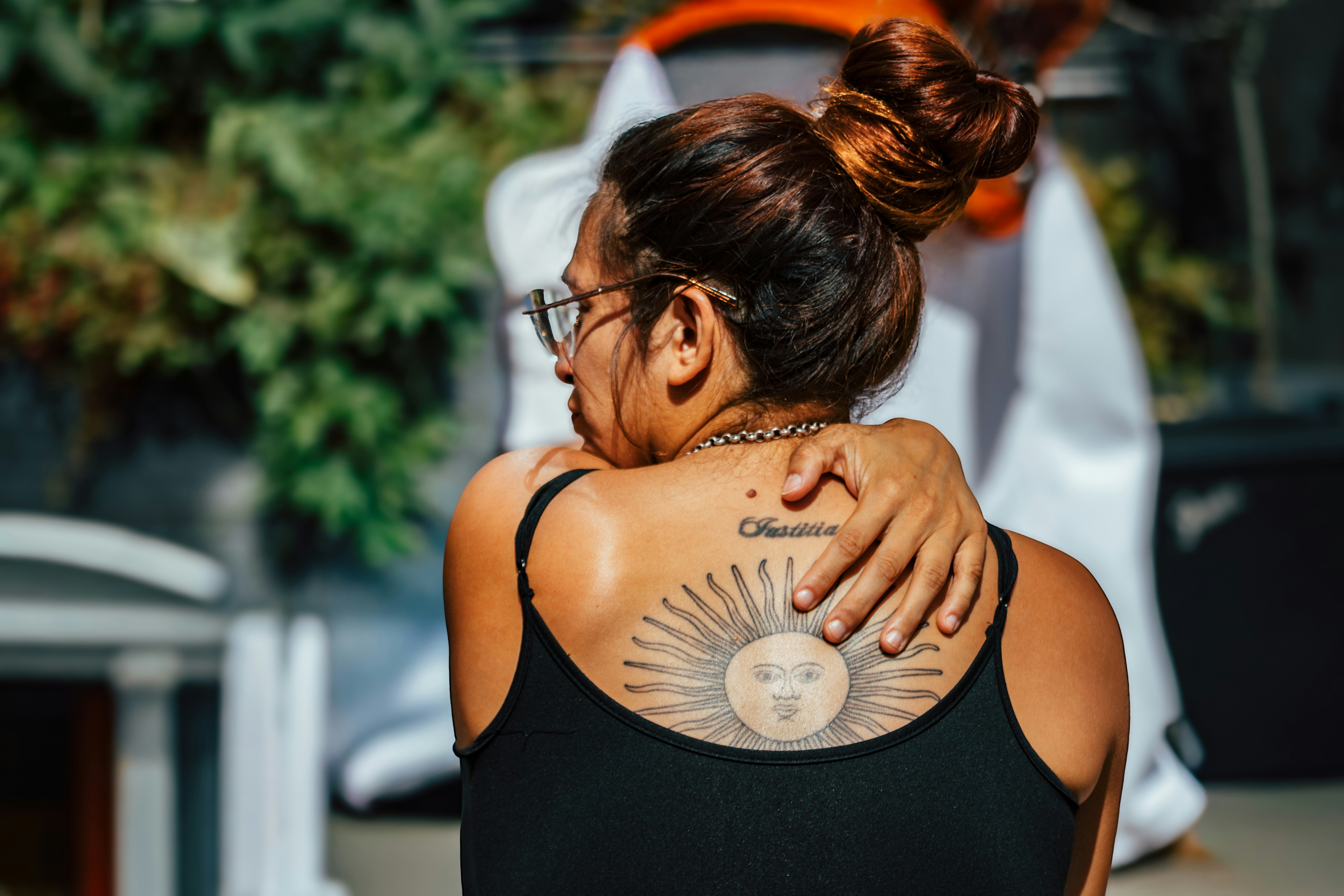 Back Tattoo, Bonded Moment: A Tattooed Spine and Embrace