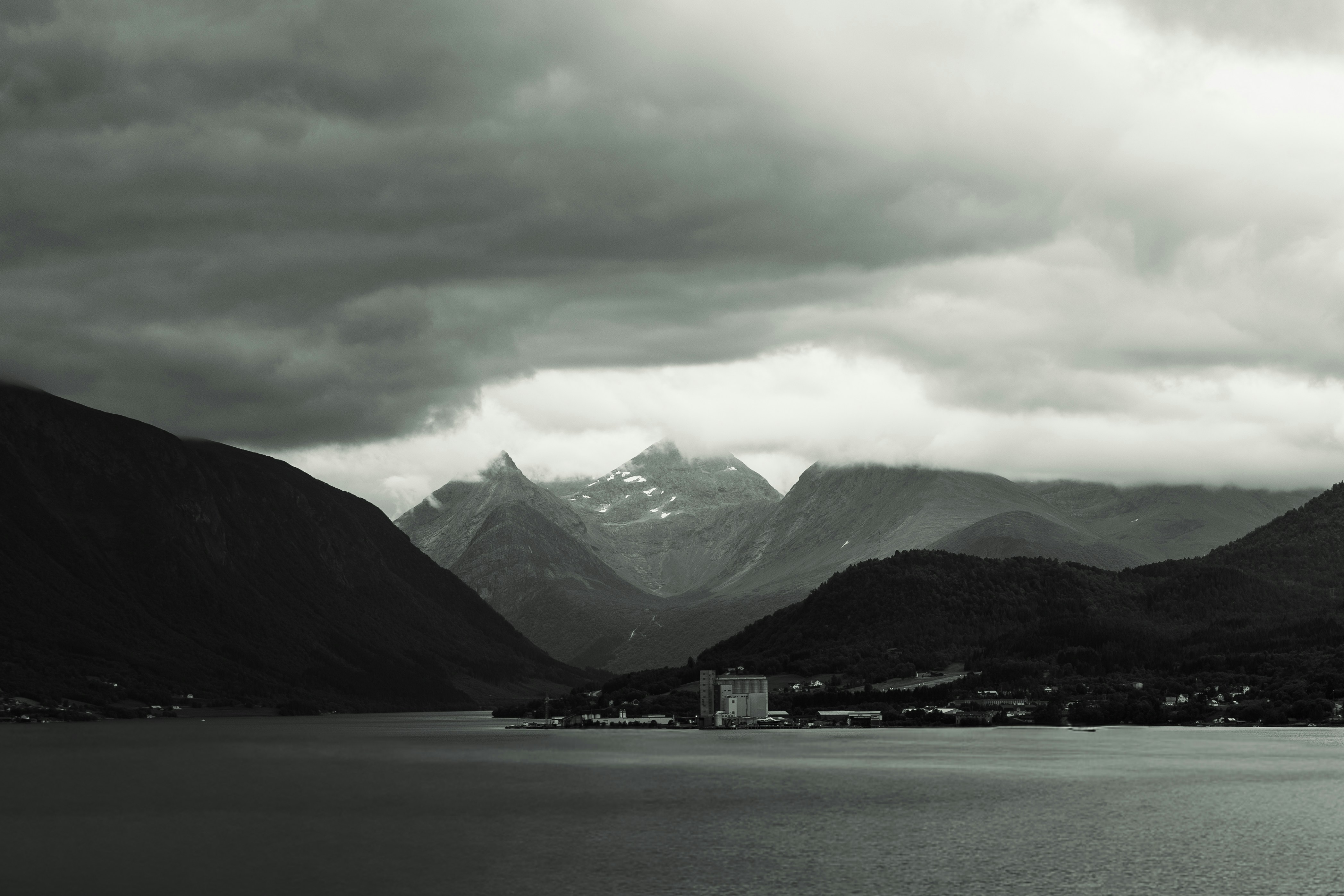 Storm-Lashed Fjord: Distant Peaks Under Heavy Skies