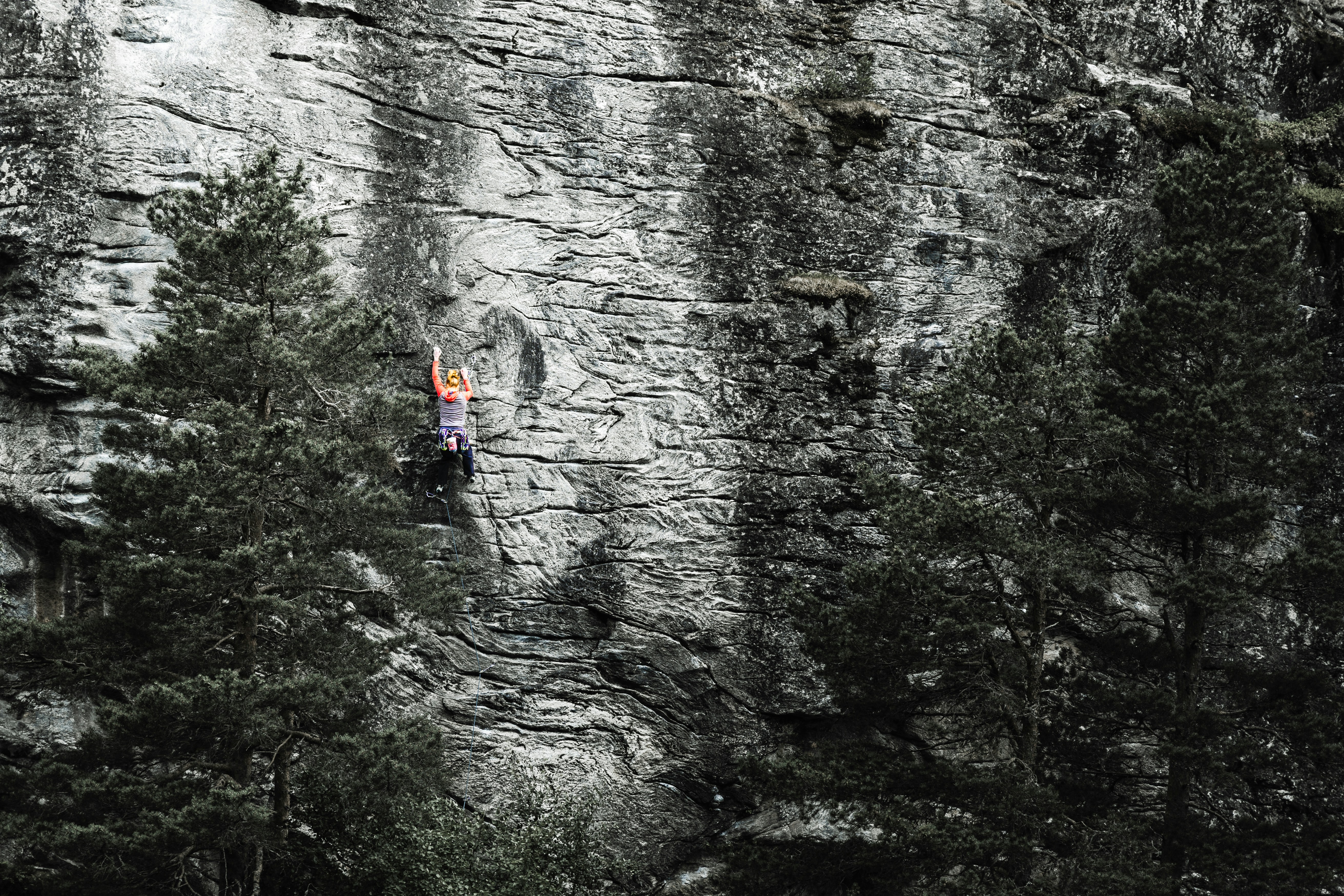 Climber Ascends a Weathered Granite Face
