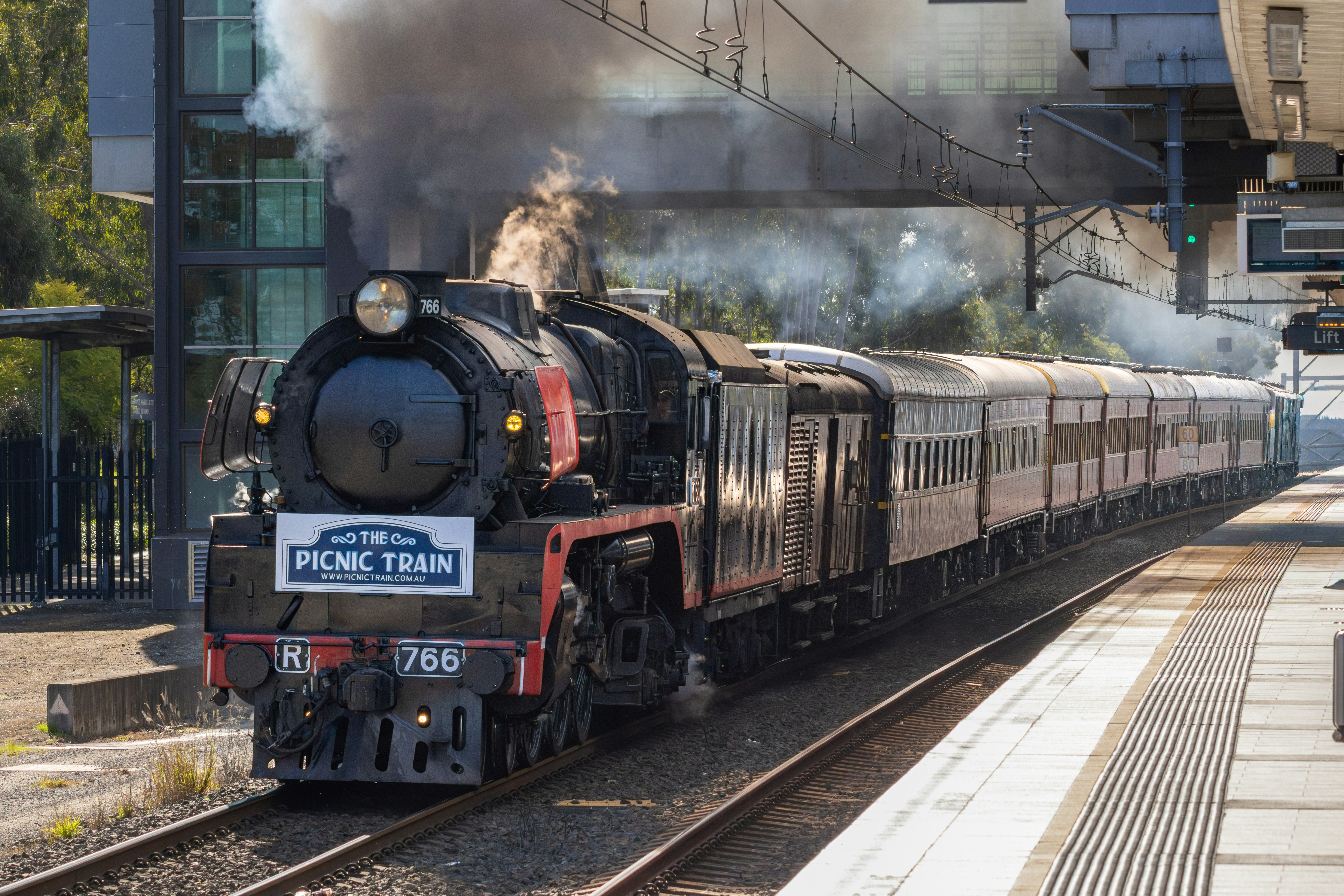 Steam Locomotive in Steam-Cloaked Urban Platform