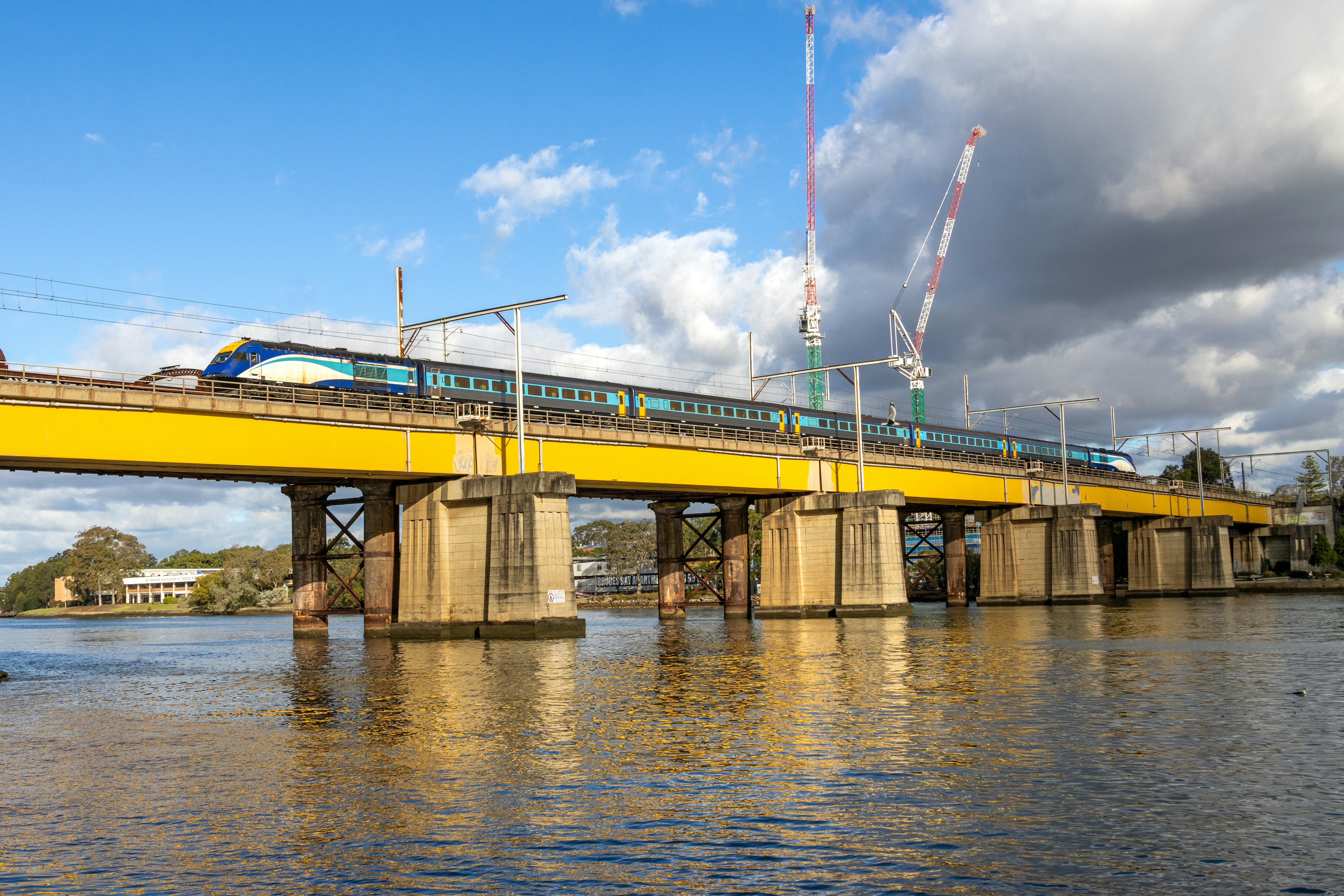 Yellow Truss and Rails: Vista Across the River