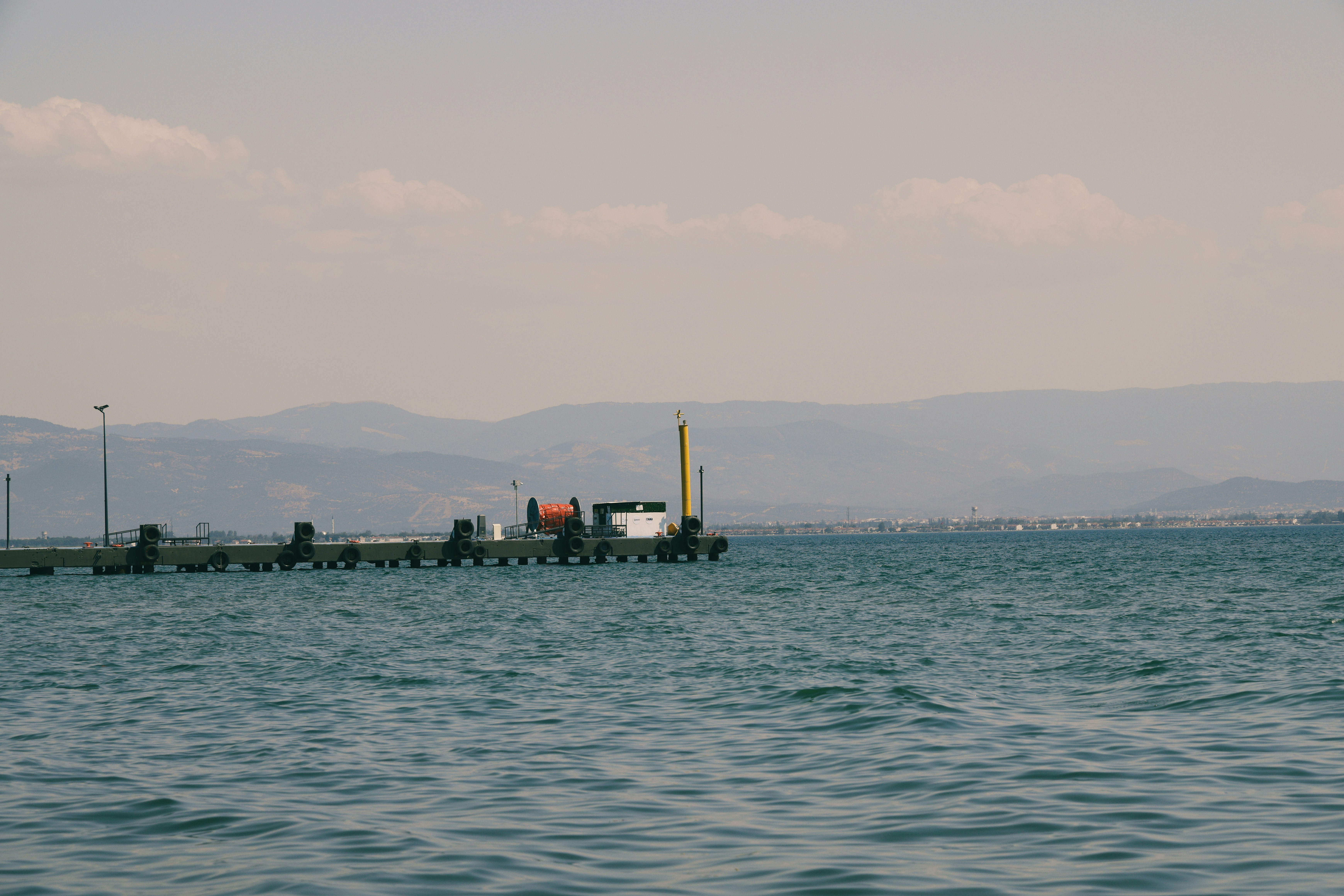 Pier at Sea: Distant Horizon and Quiet Wake