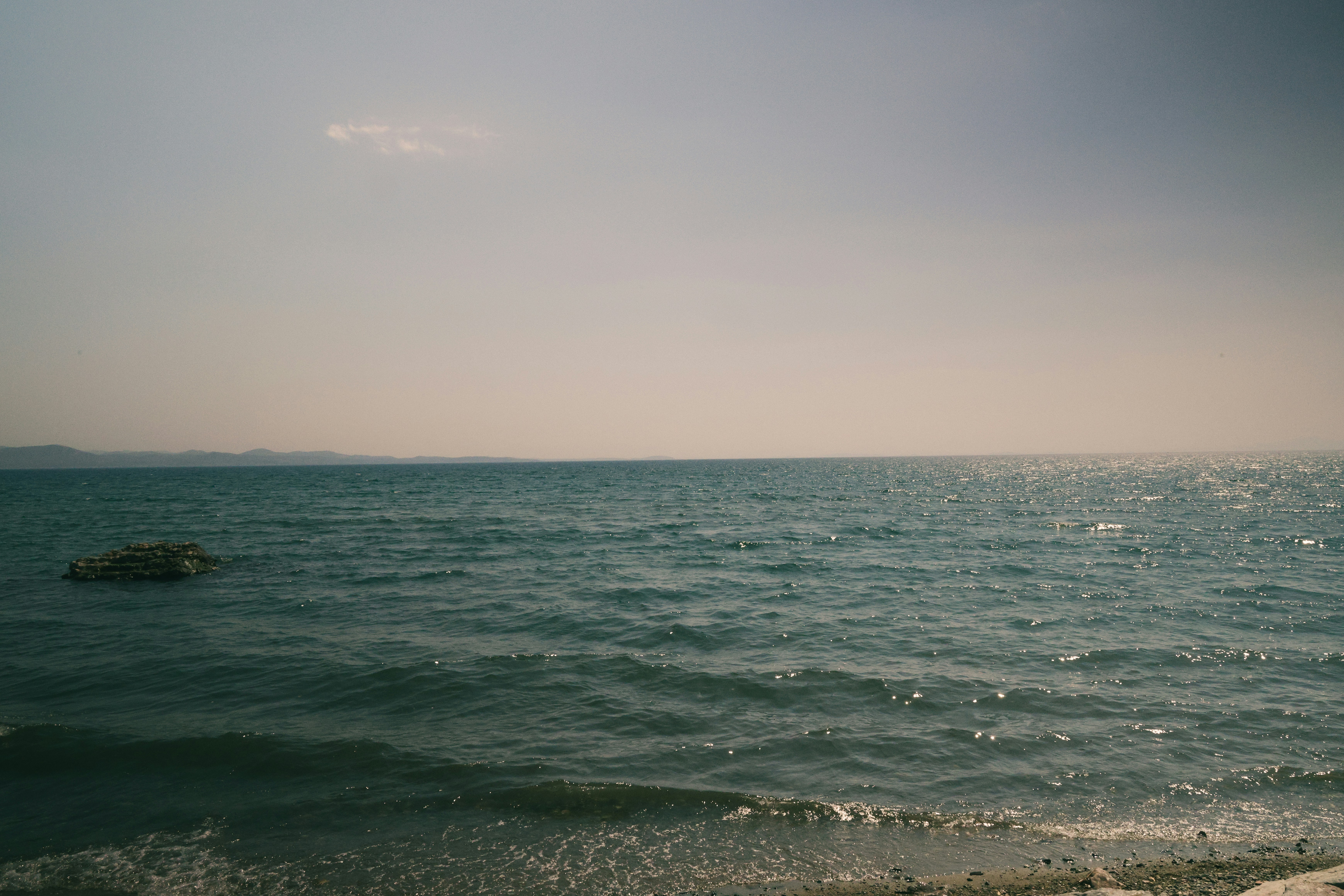 Glassy Horizon over a Quiet Coastal Sea at Dusk