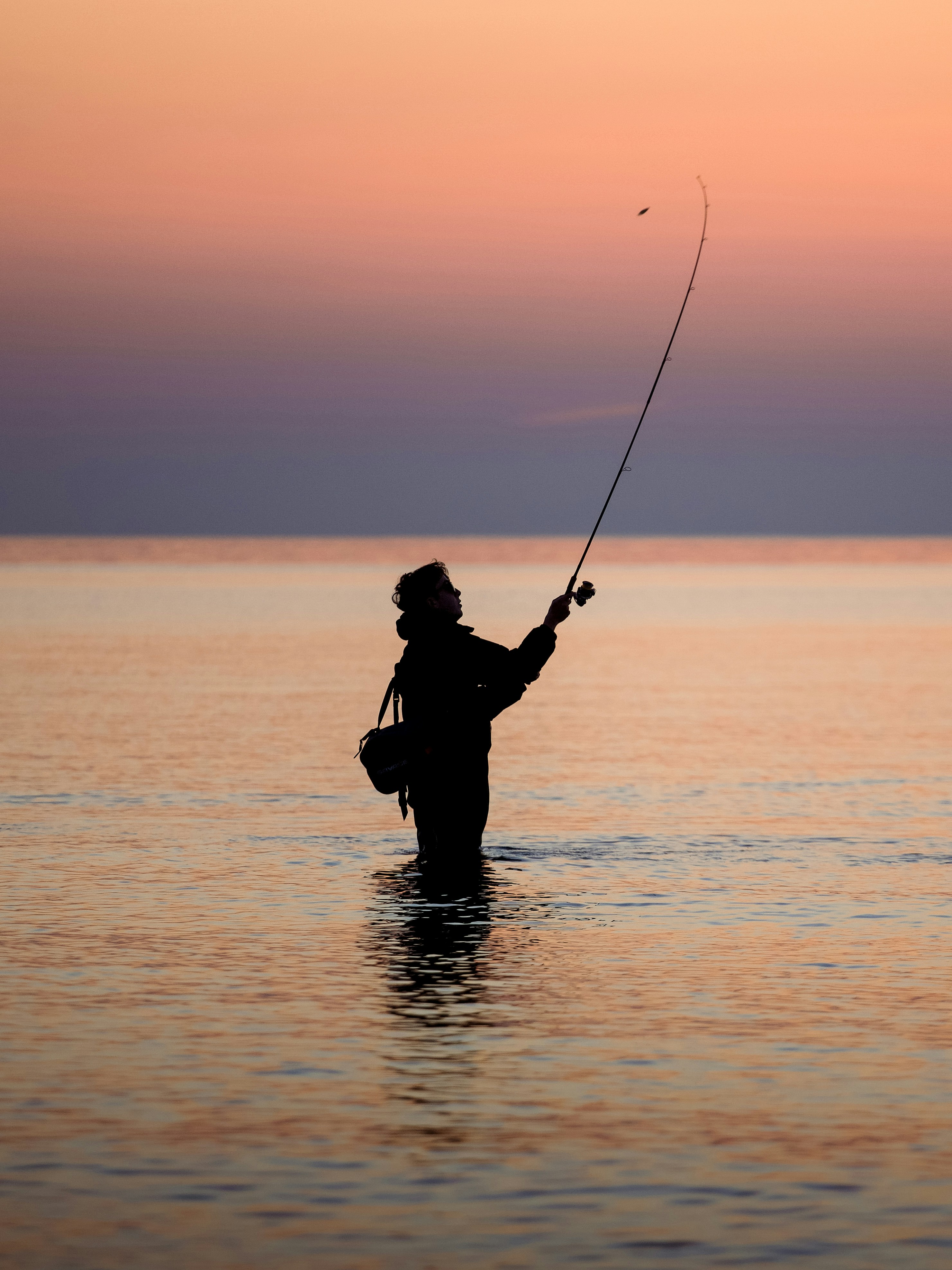 Silhouette Angler in Sunset Tide