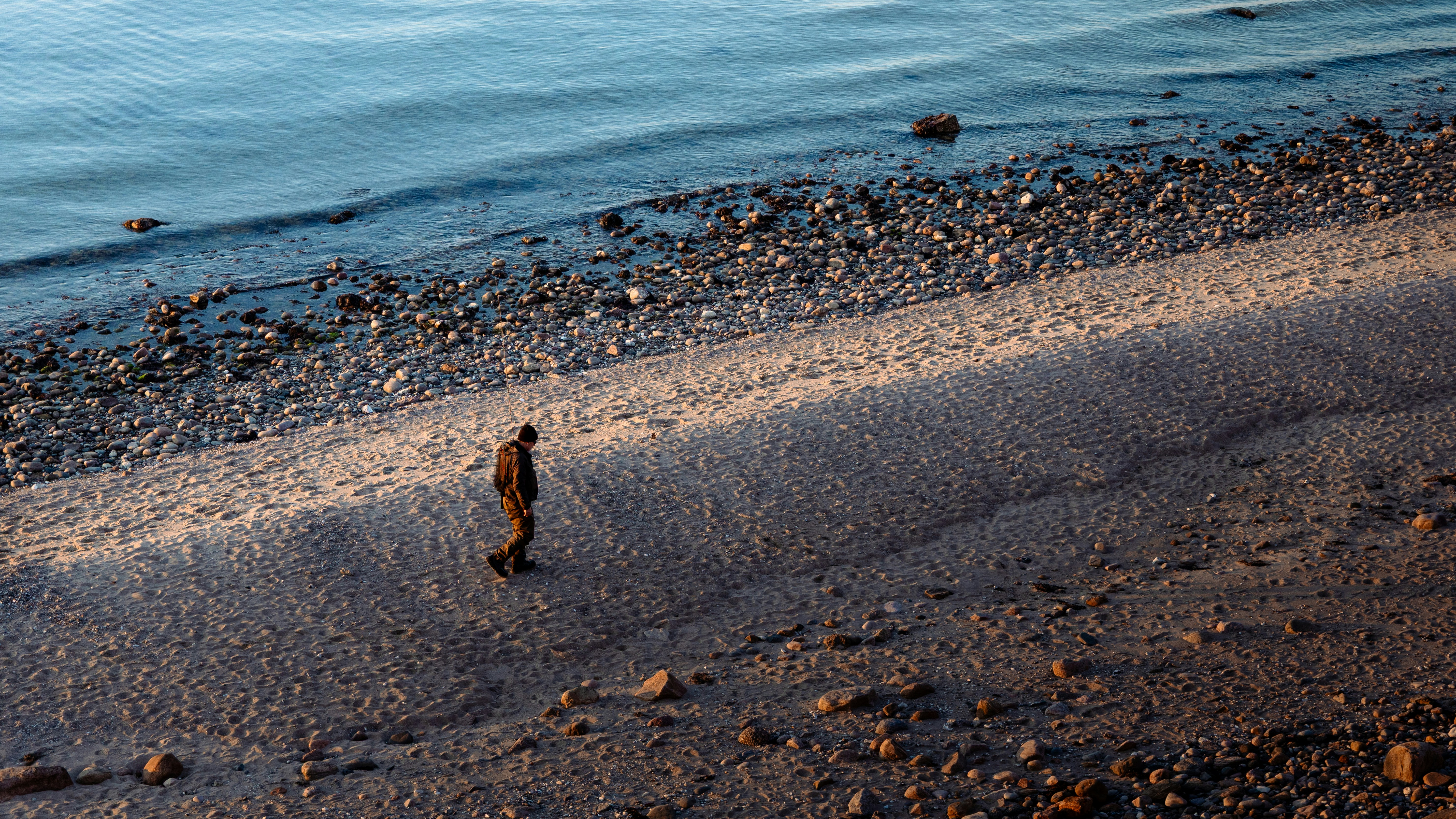 Drift on the Pebble Shore: A Lone Walker by the Sea