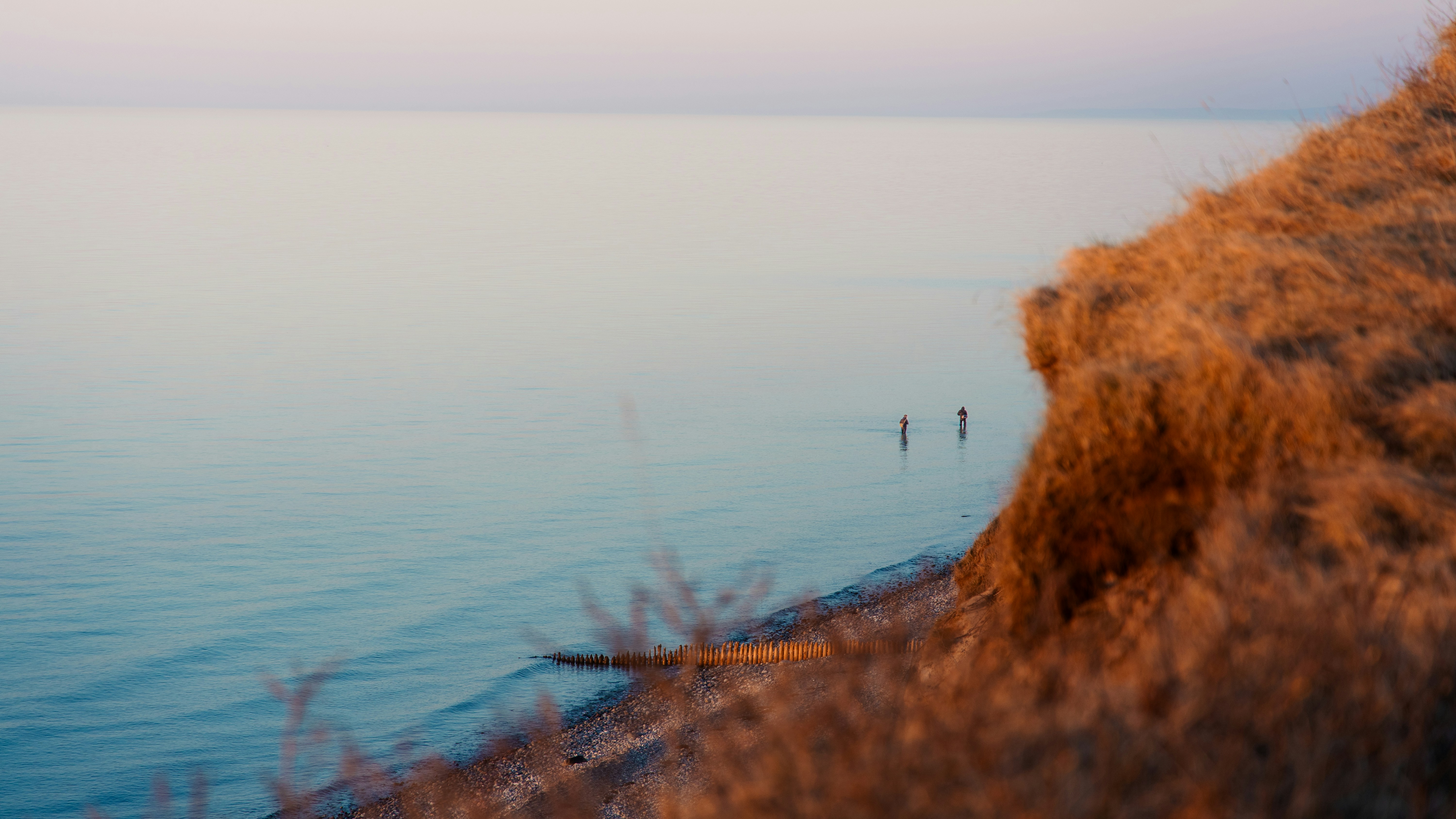 Blue Quiet: A Distant Shoreline Beyond Golden Cliffs