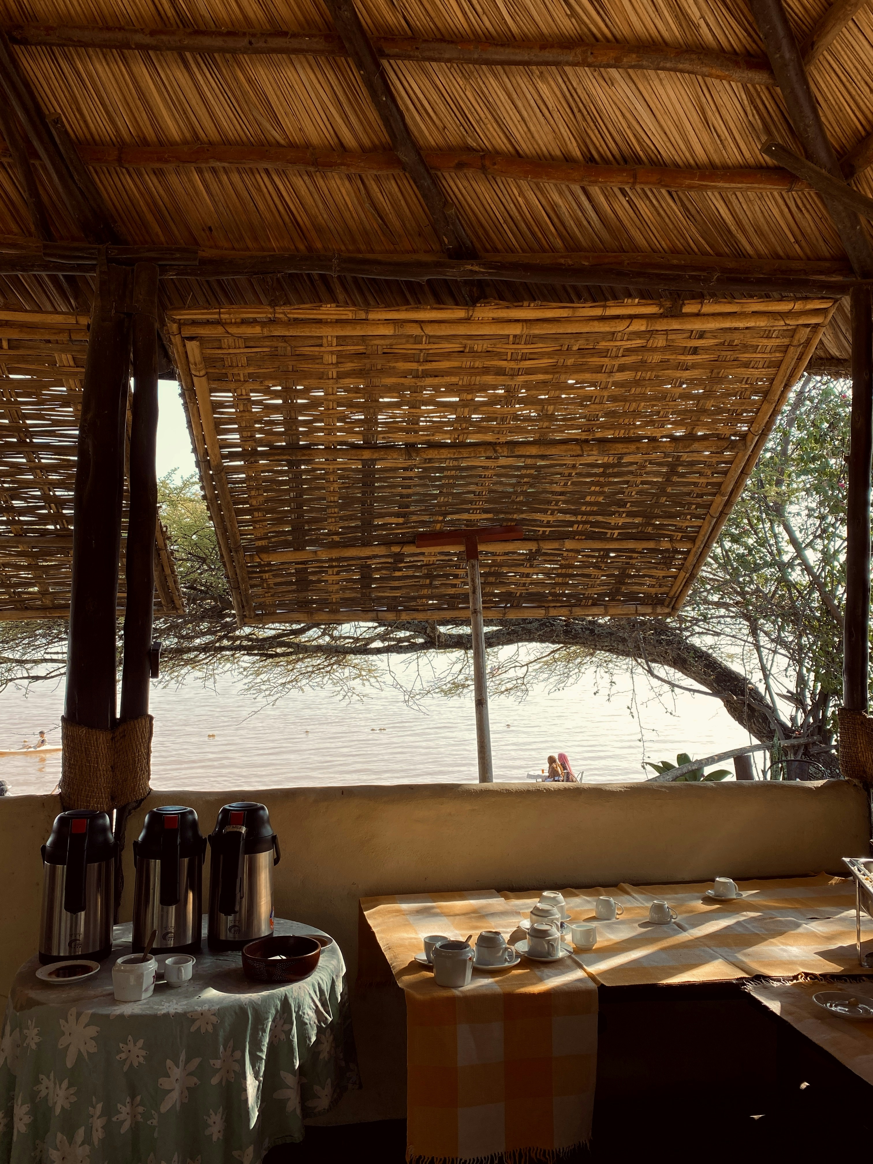 Shaded seaside café with a sunlit table setting