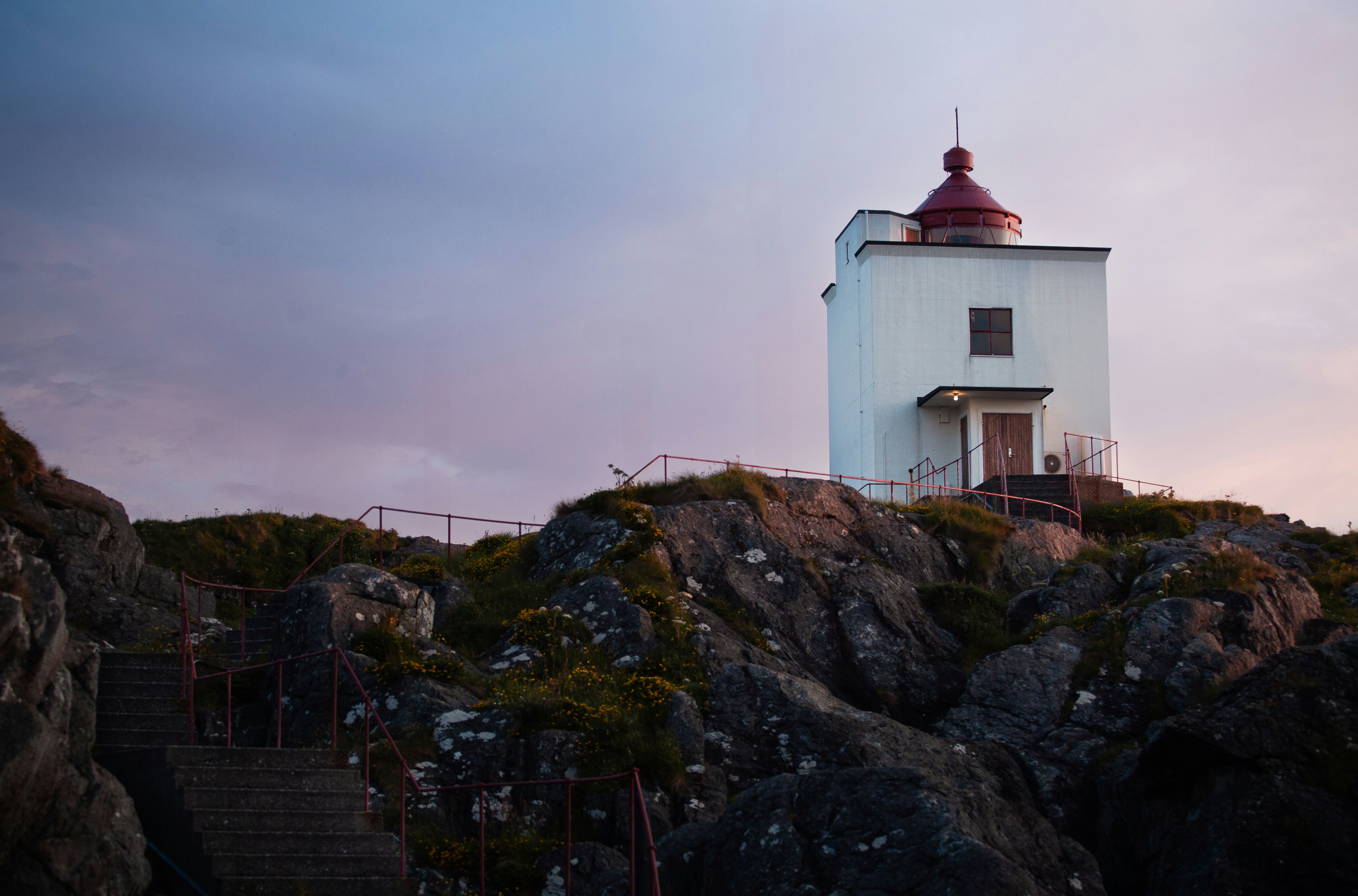 Harbor Beacon: A Seaside Lighthouse Standing Guard Over Craggy Cliffs
