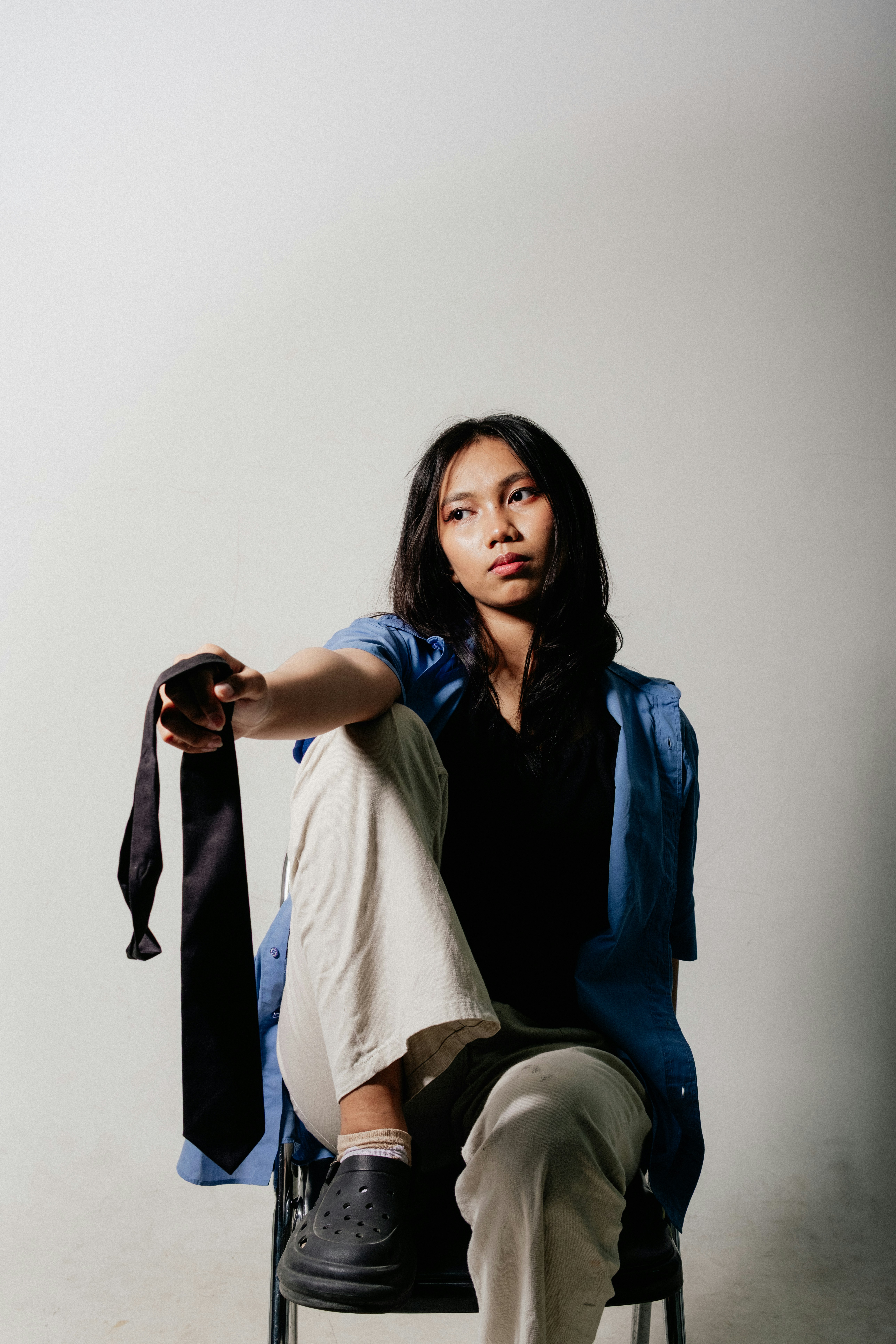 Contemplative Gaze: A Casual Pose with a Tie as Prop