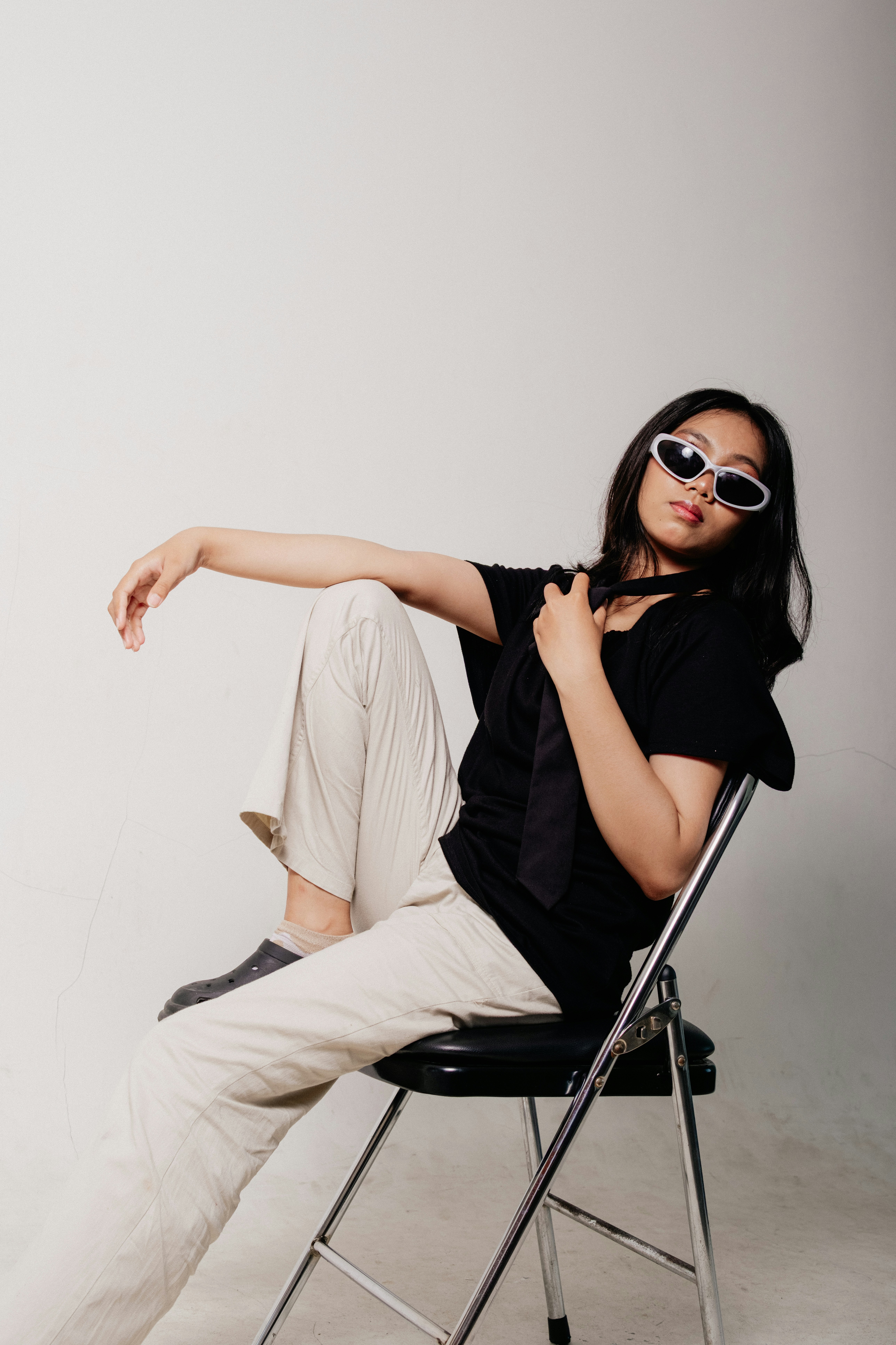 Chic Soirée: A Sunglasses-Clad Moment on a Minimal Stage