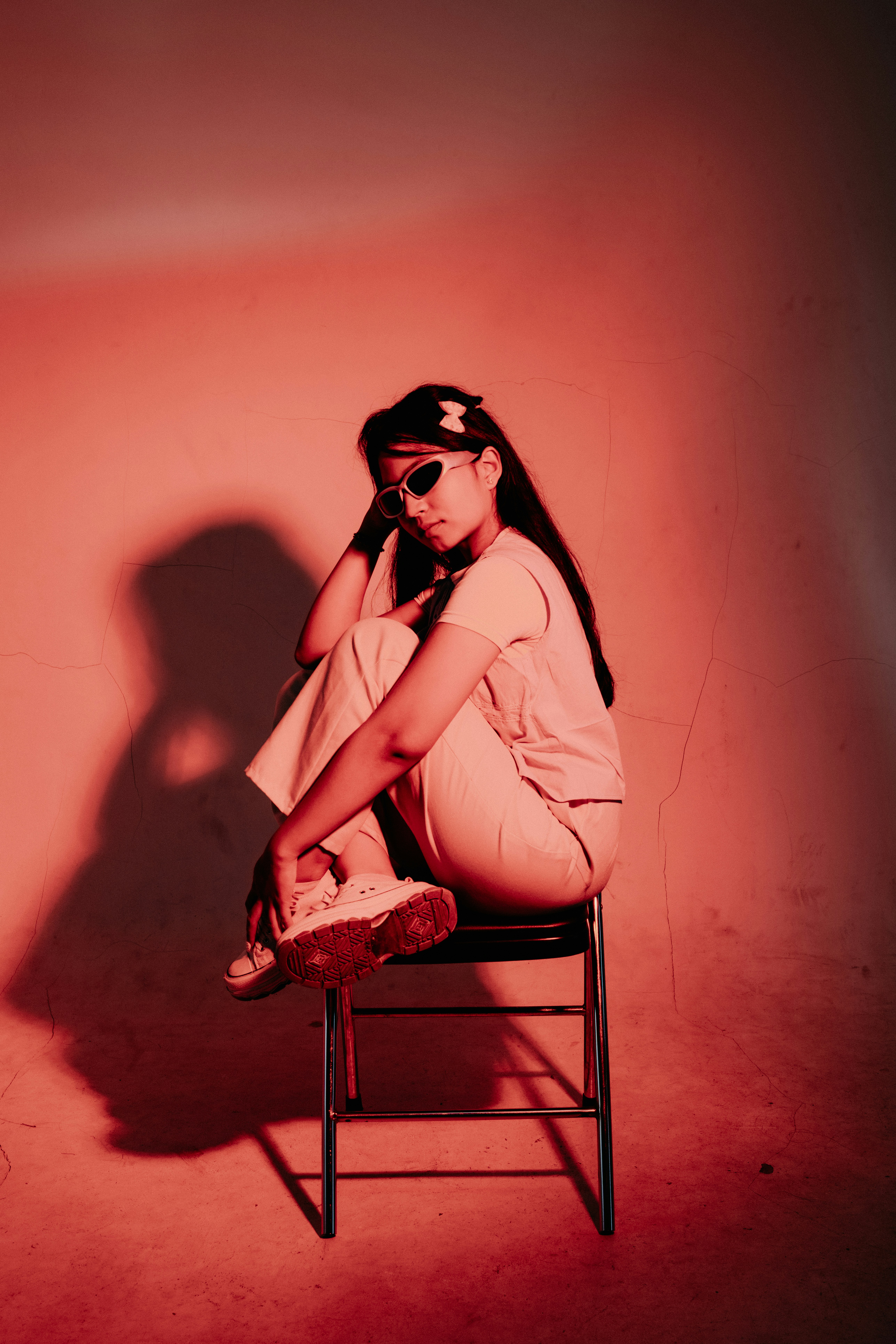 Scarlet Silhouette: A Quiet Moment on a Stool