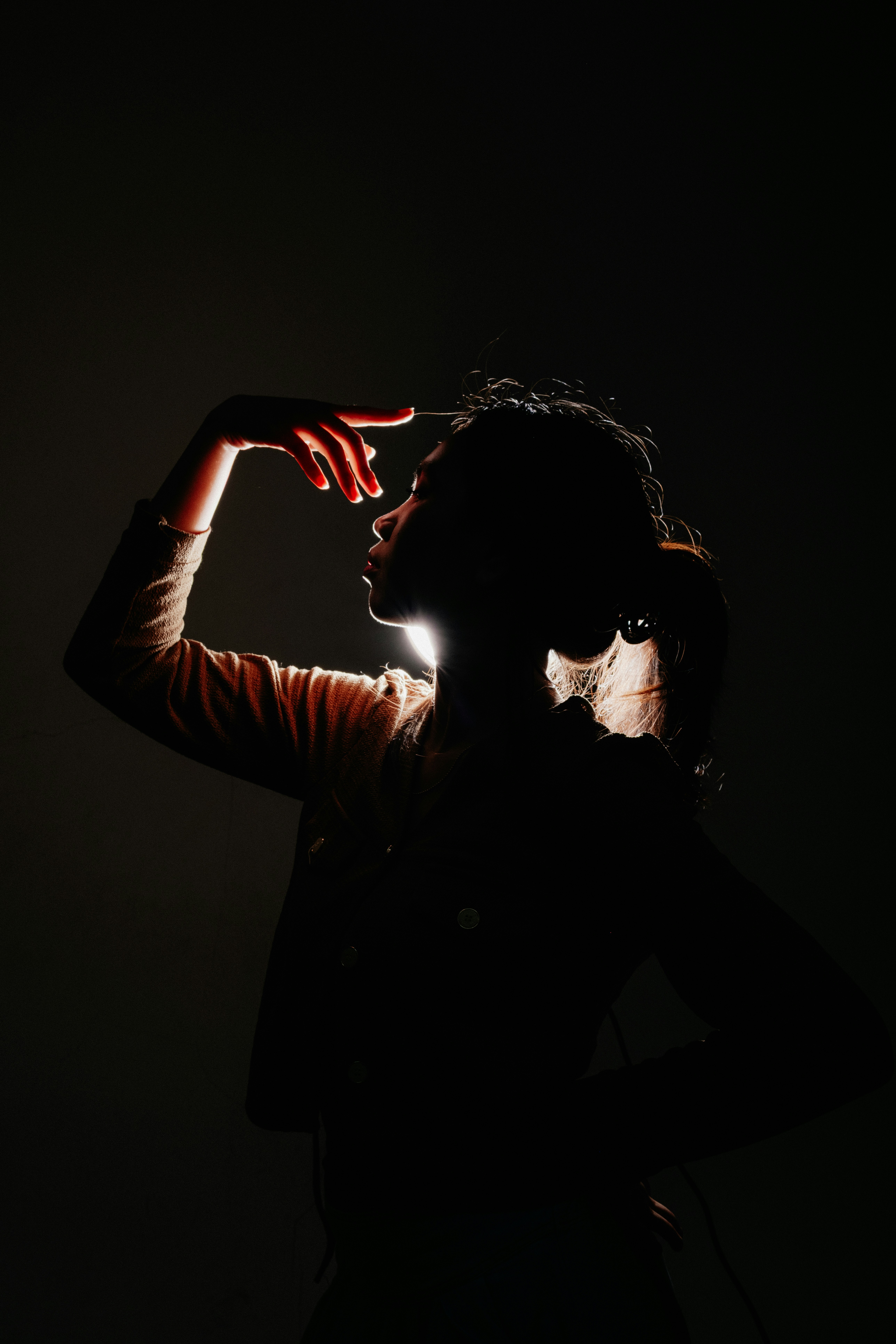 Backlit Silhouette: A Quiet Gesture in Shadowed Light