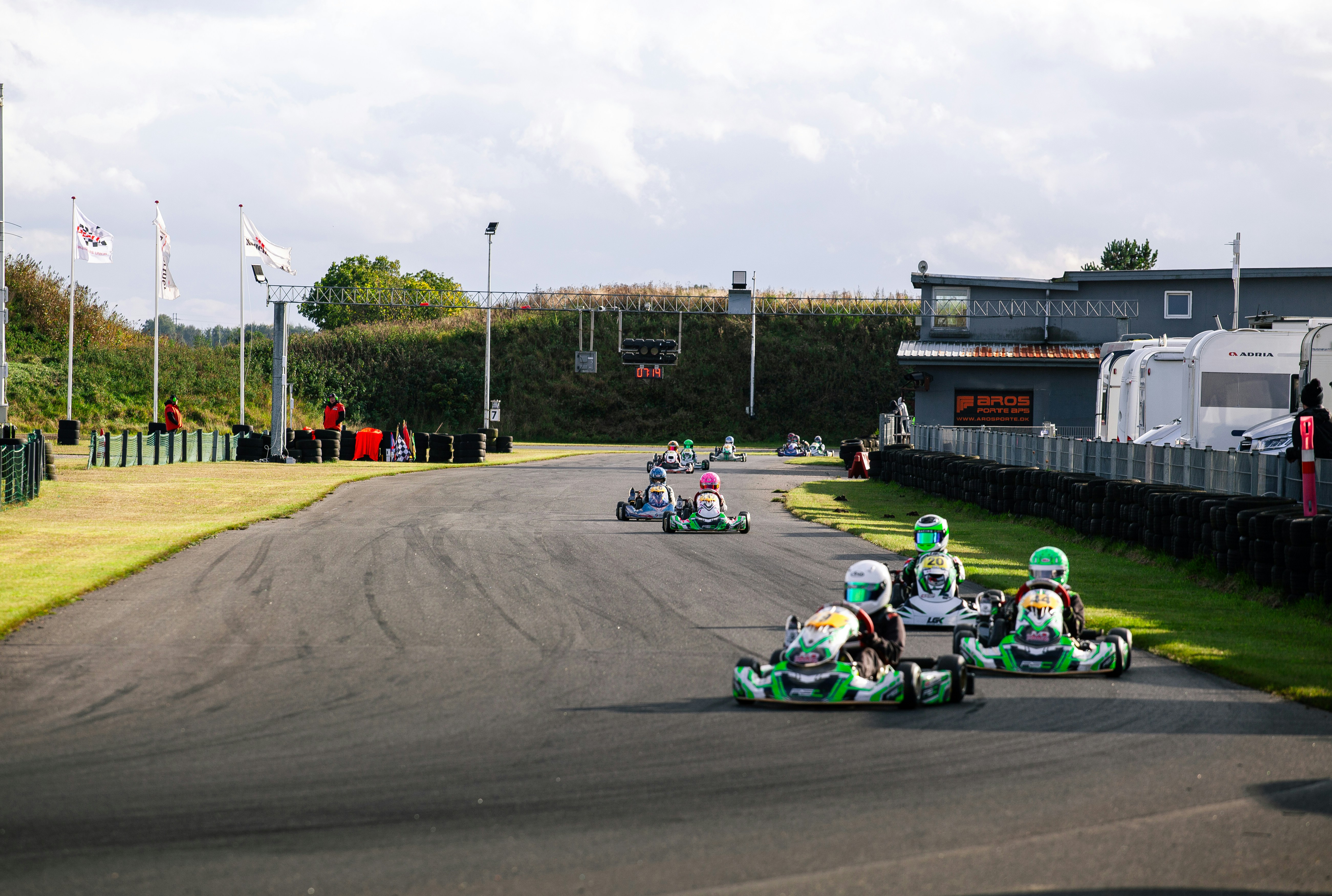 Green‑Lashed Start: Go-Karts Sprint from the Paddock