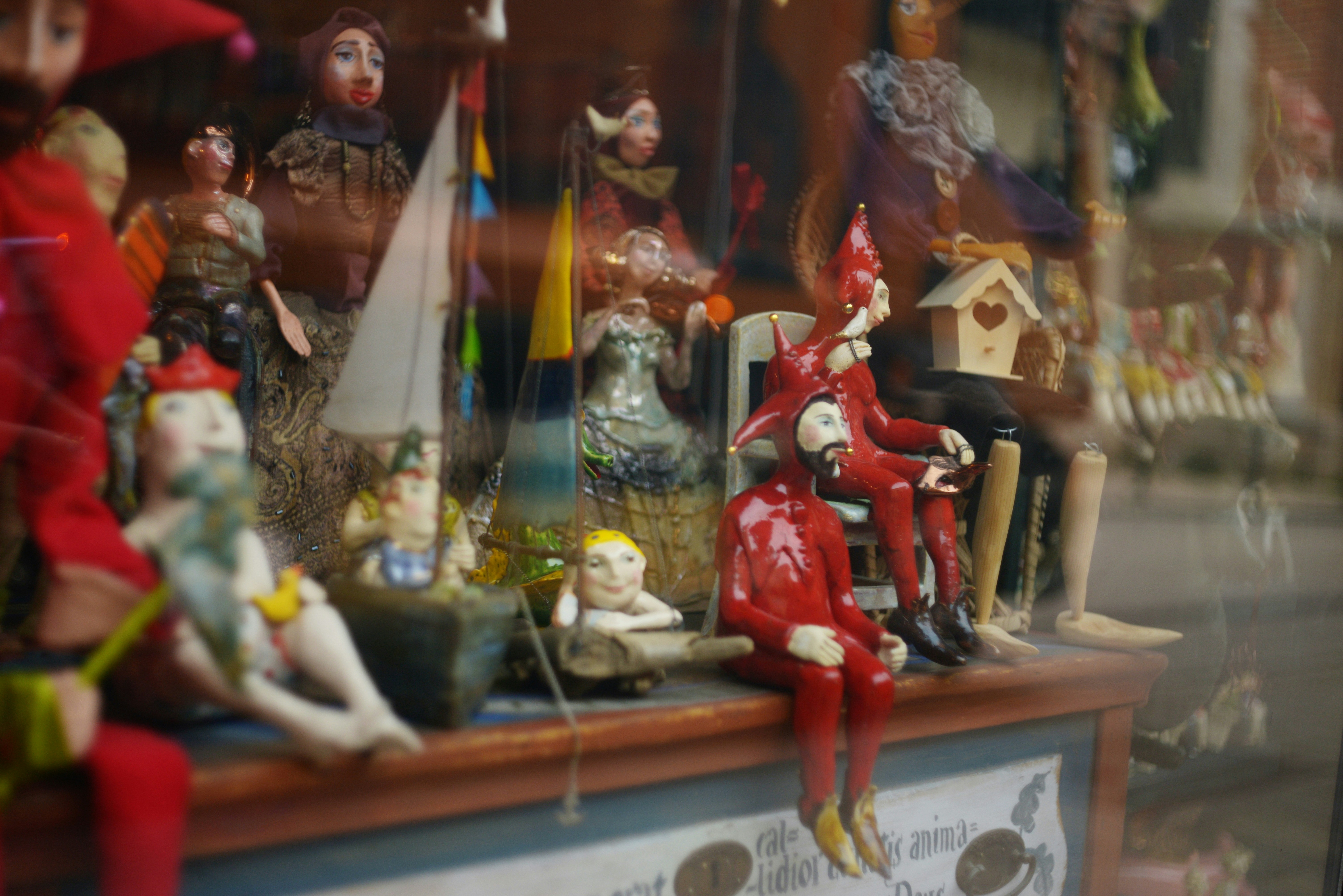 Curious Marionettes on a Window Shelf