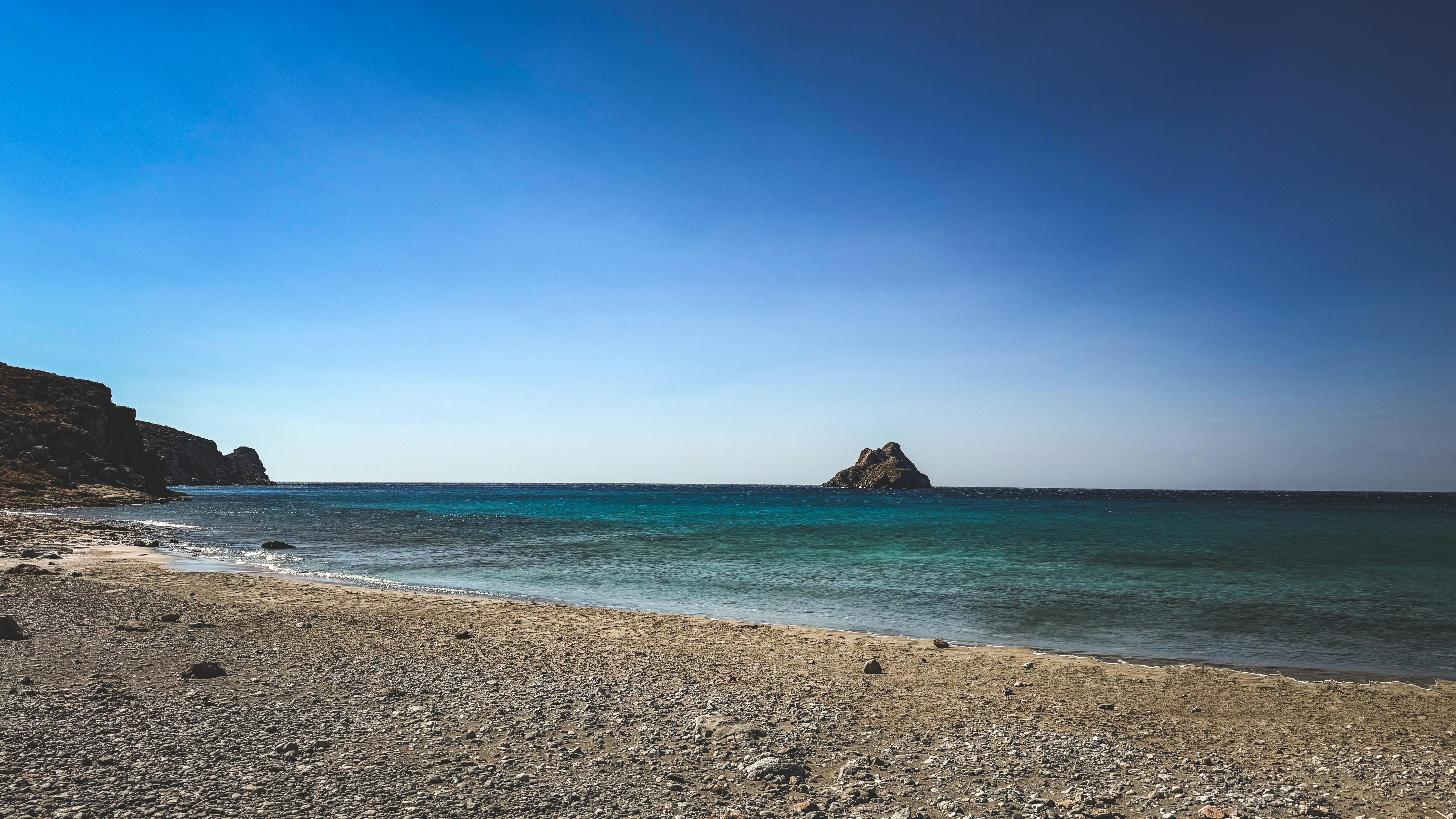 Coastal Horizon: Quiet Beach Under a Clear Sky