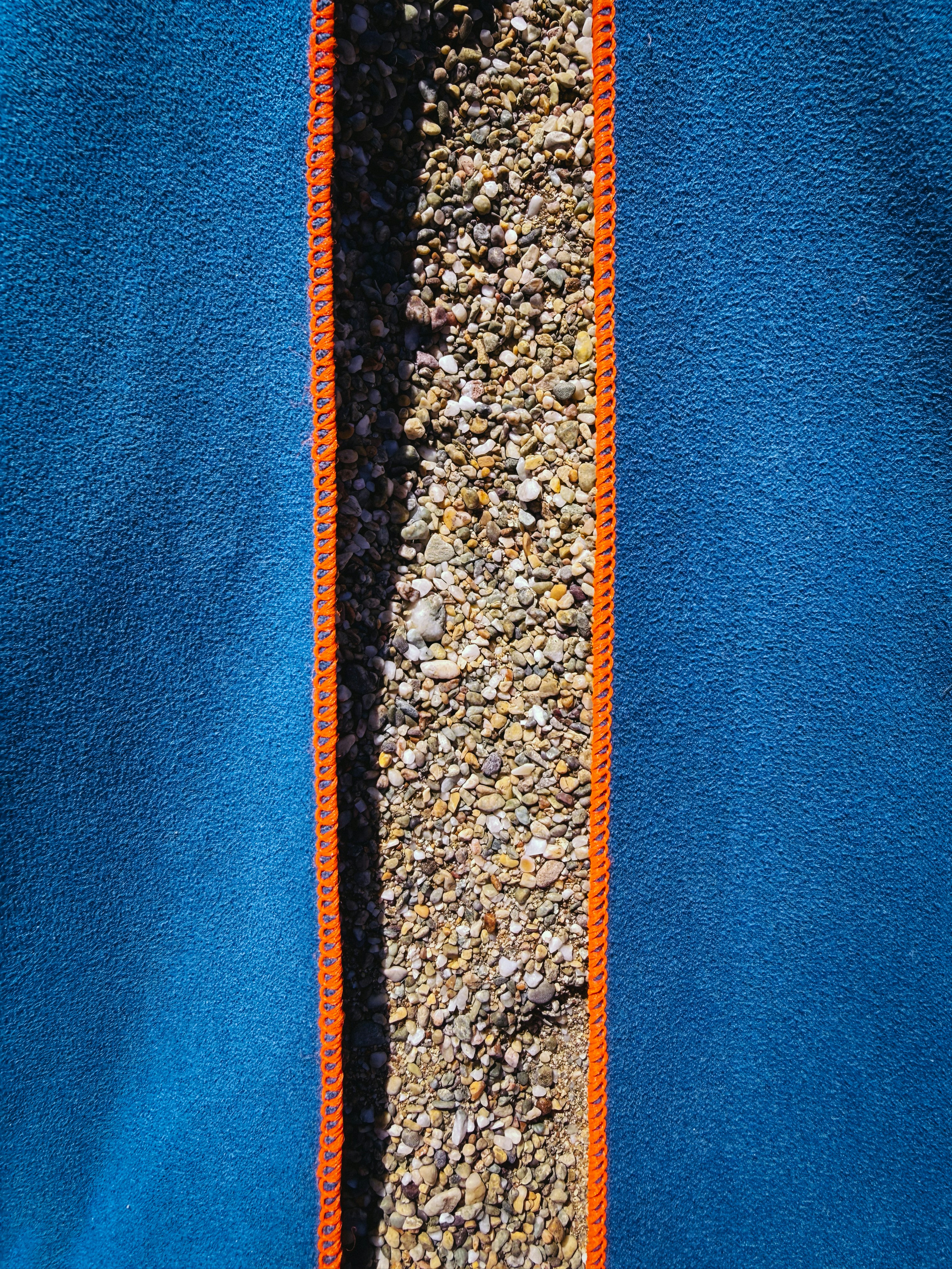 Between the Blue Strips: Pebble Channel of a Colorful Path