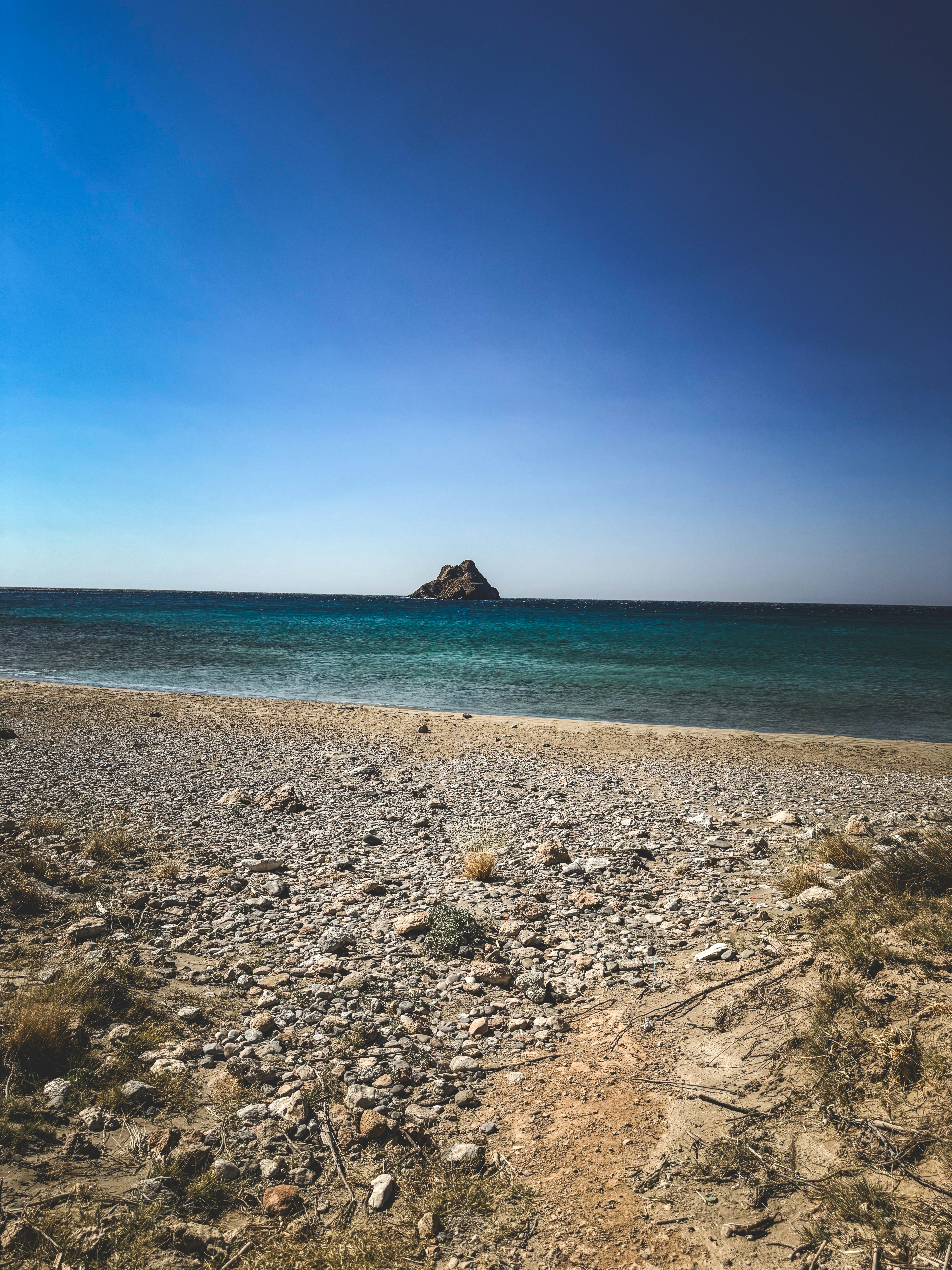 A Quiet Sea Island Emerges from the Horizon