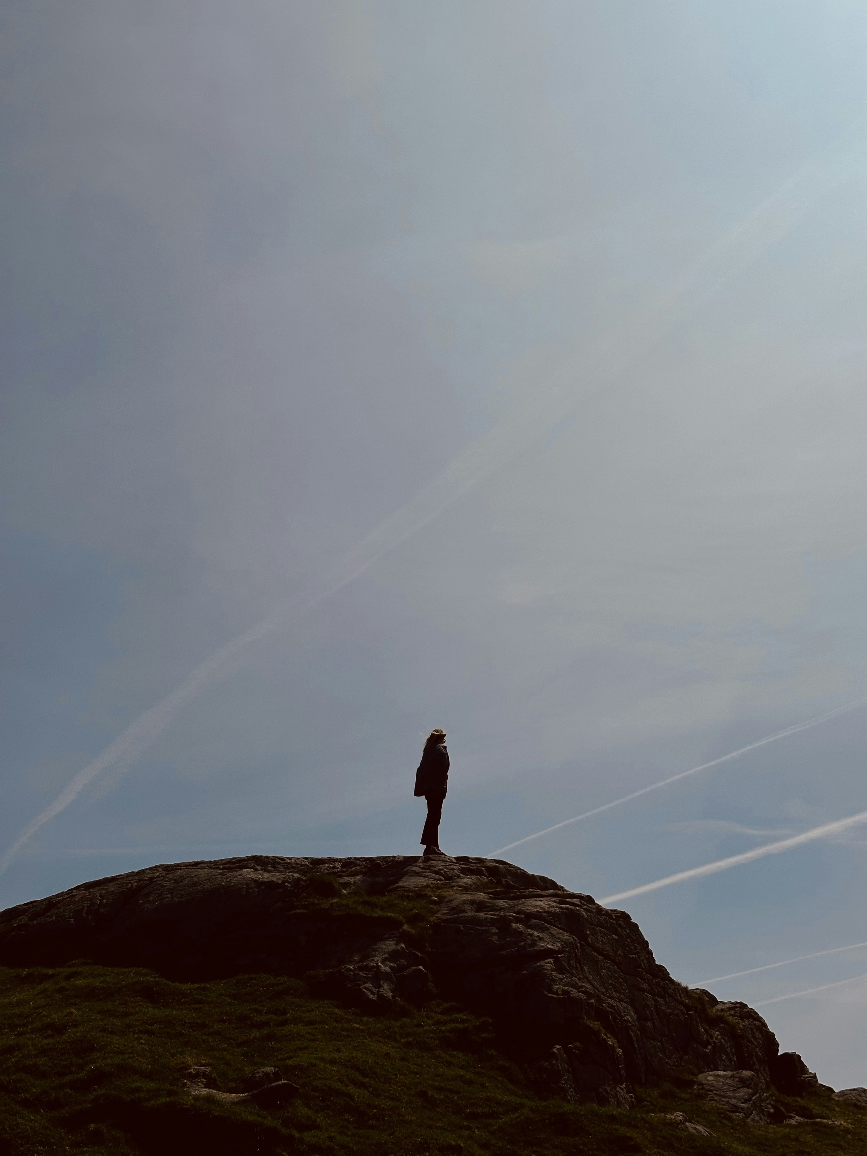On the Edge: A Lone Figure Beneath the Sky
