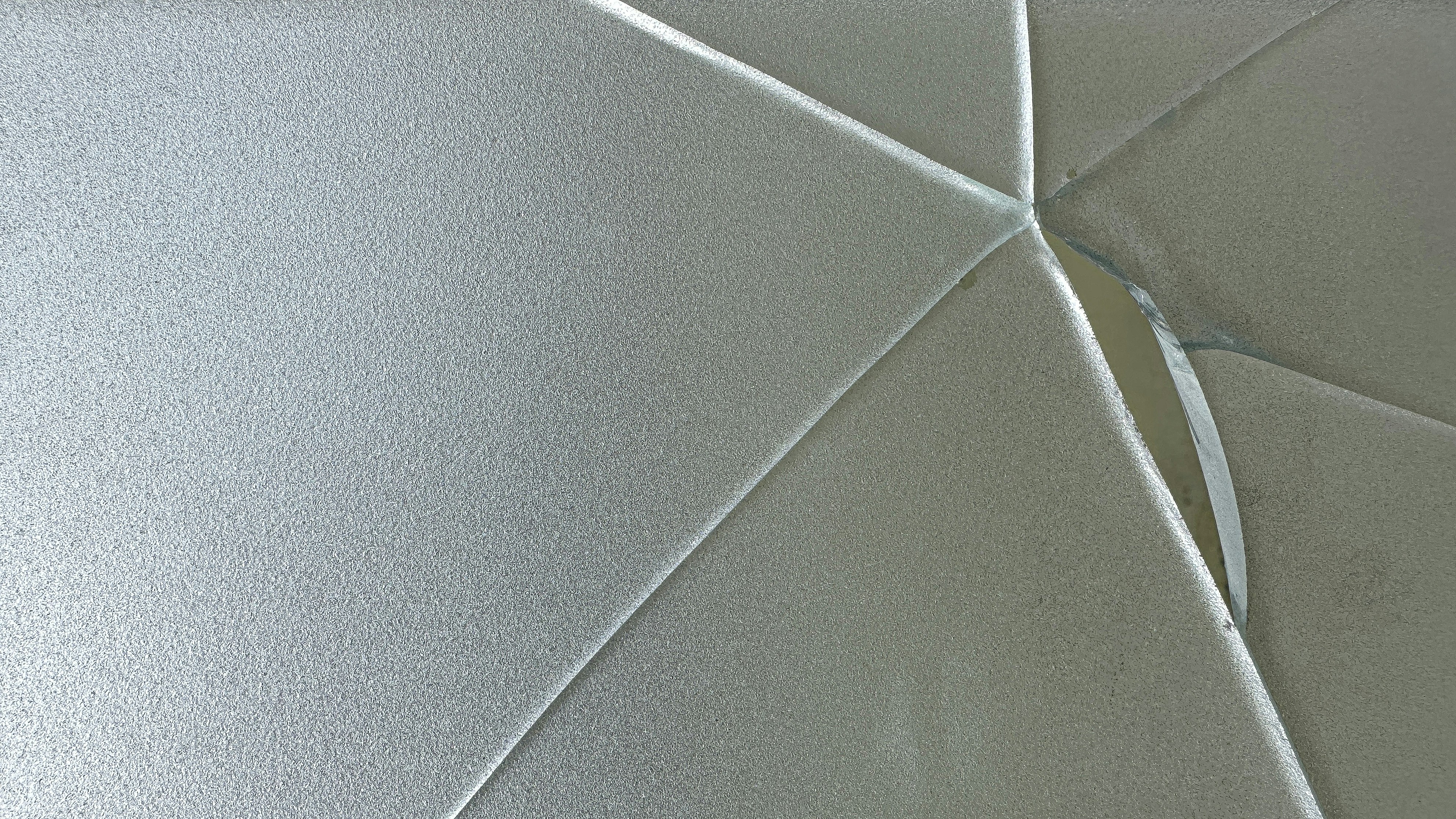 Cracked Cardboard Canopy: Subtle Lines Converge in Soft Gray Texture