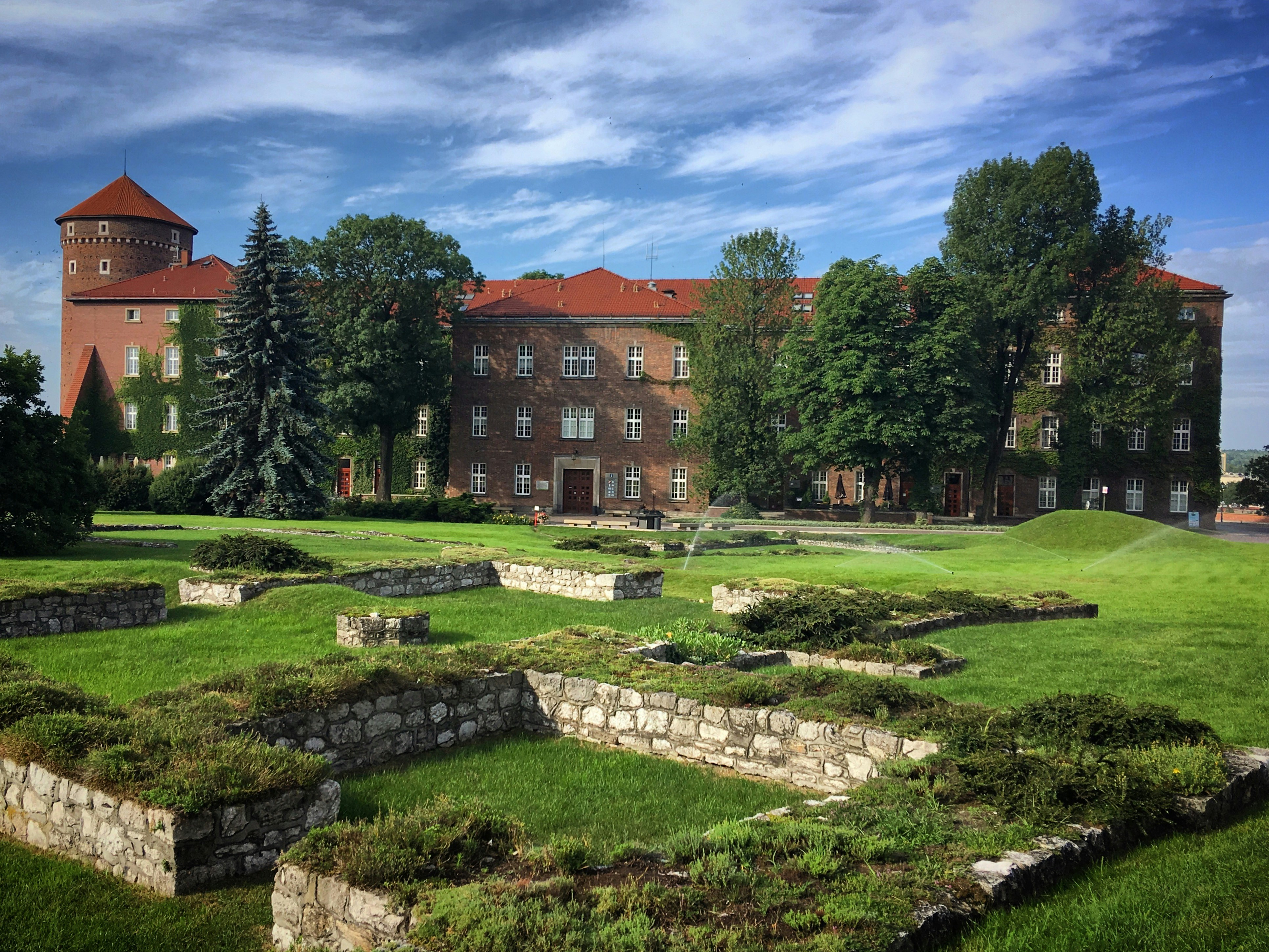 Medieval Grounds: Sunlit Cloistered Courtyard in a Red Brick Estate