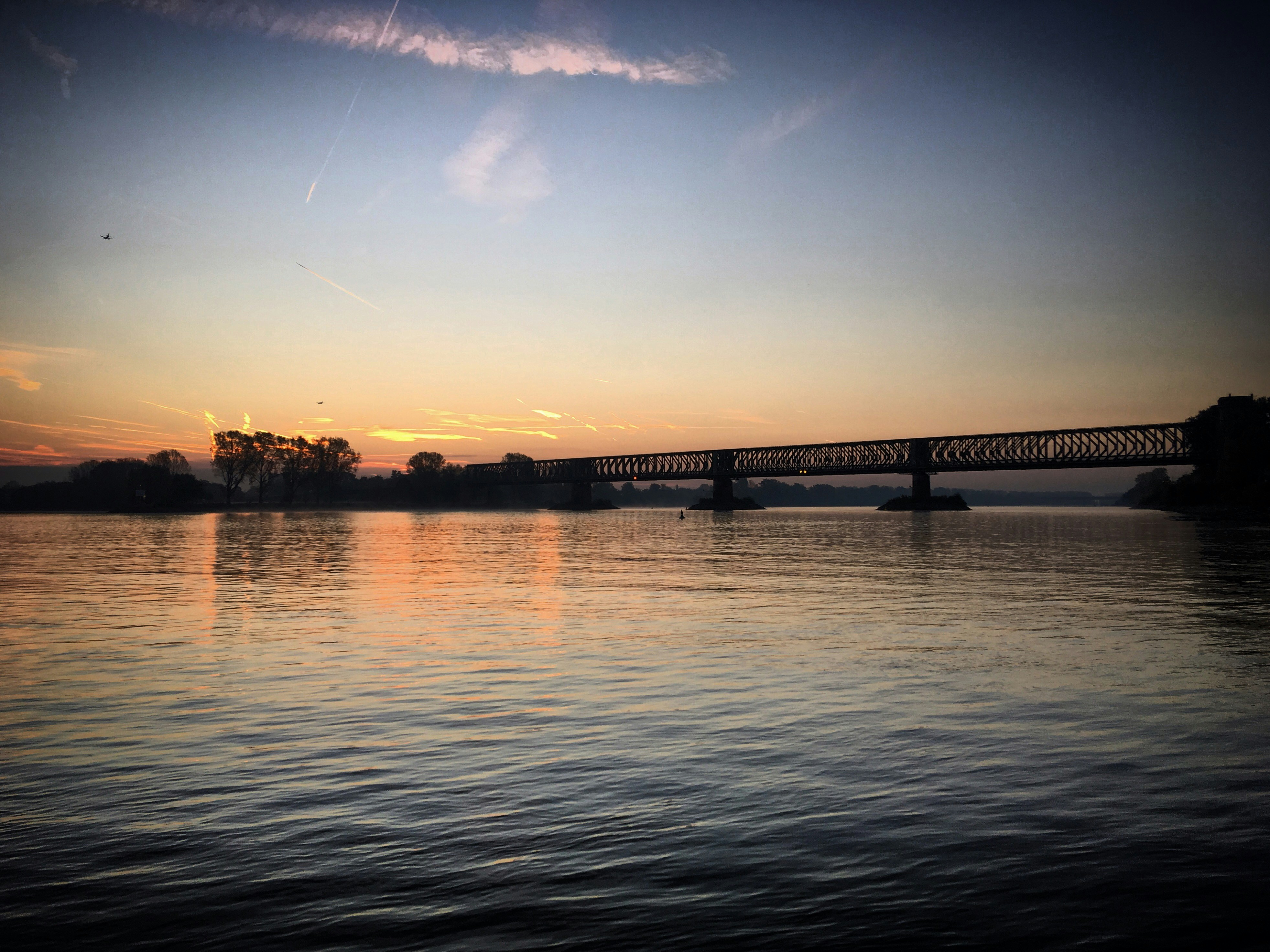 Sunset Rail Reflections: A Quiet River Crossing