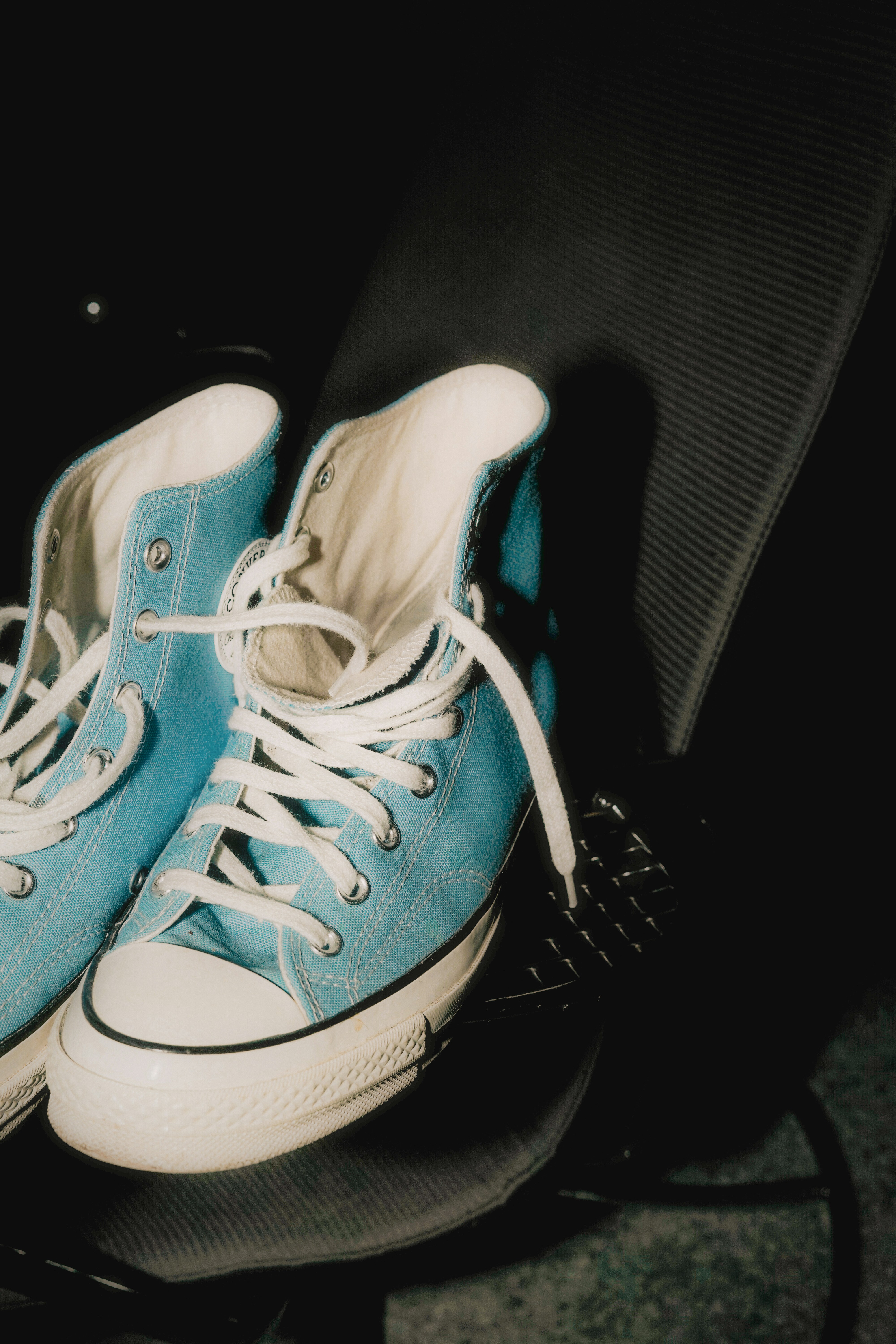 Blue Kicks in the Spotlight: A Quiet Moment on the Studio Chair