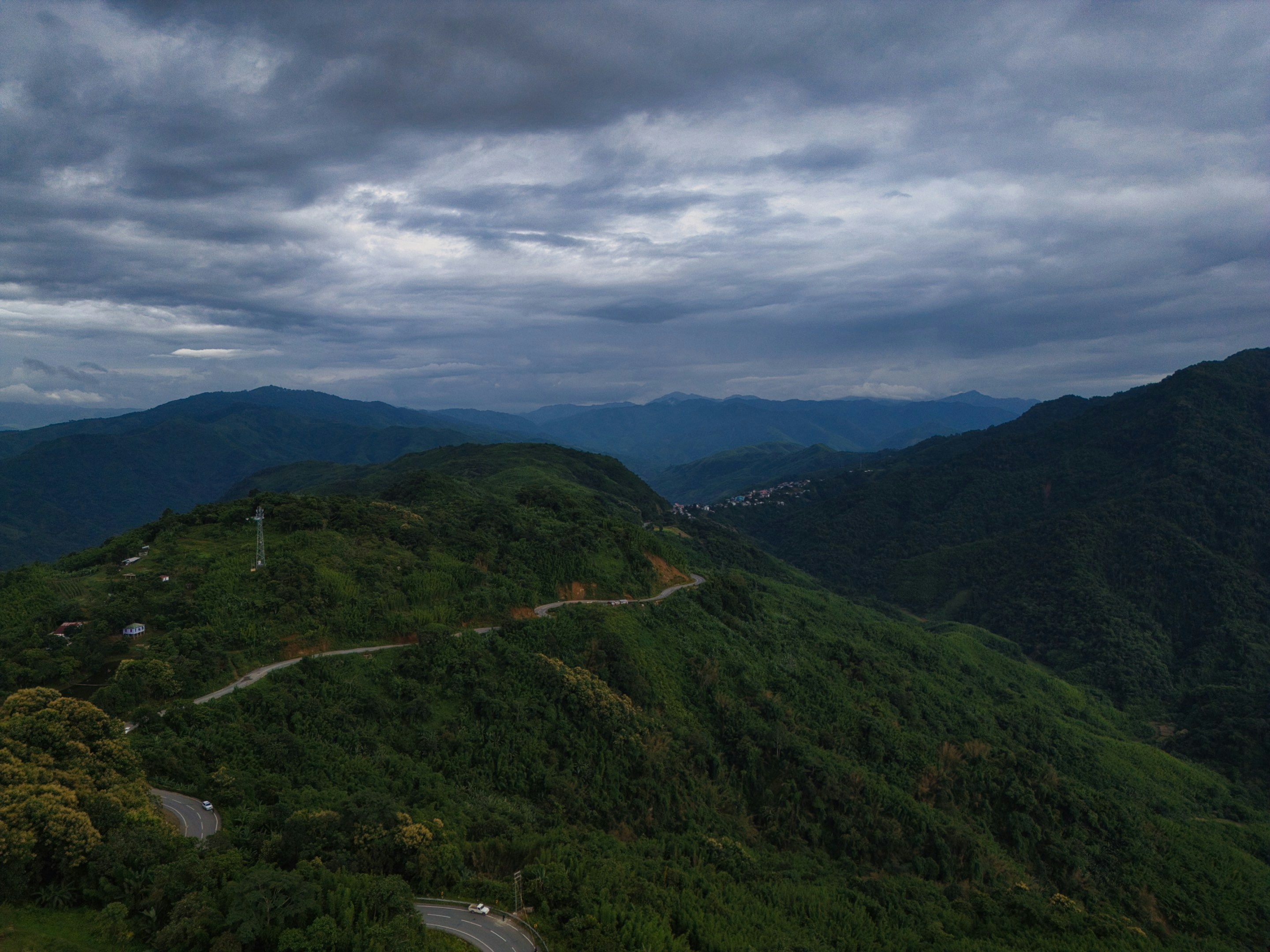 Hiker’s Horizon: A Verdant Ridge under a Brooding Sky