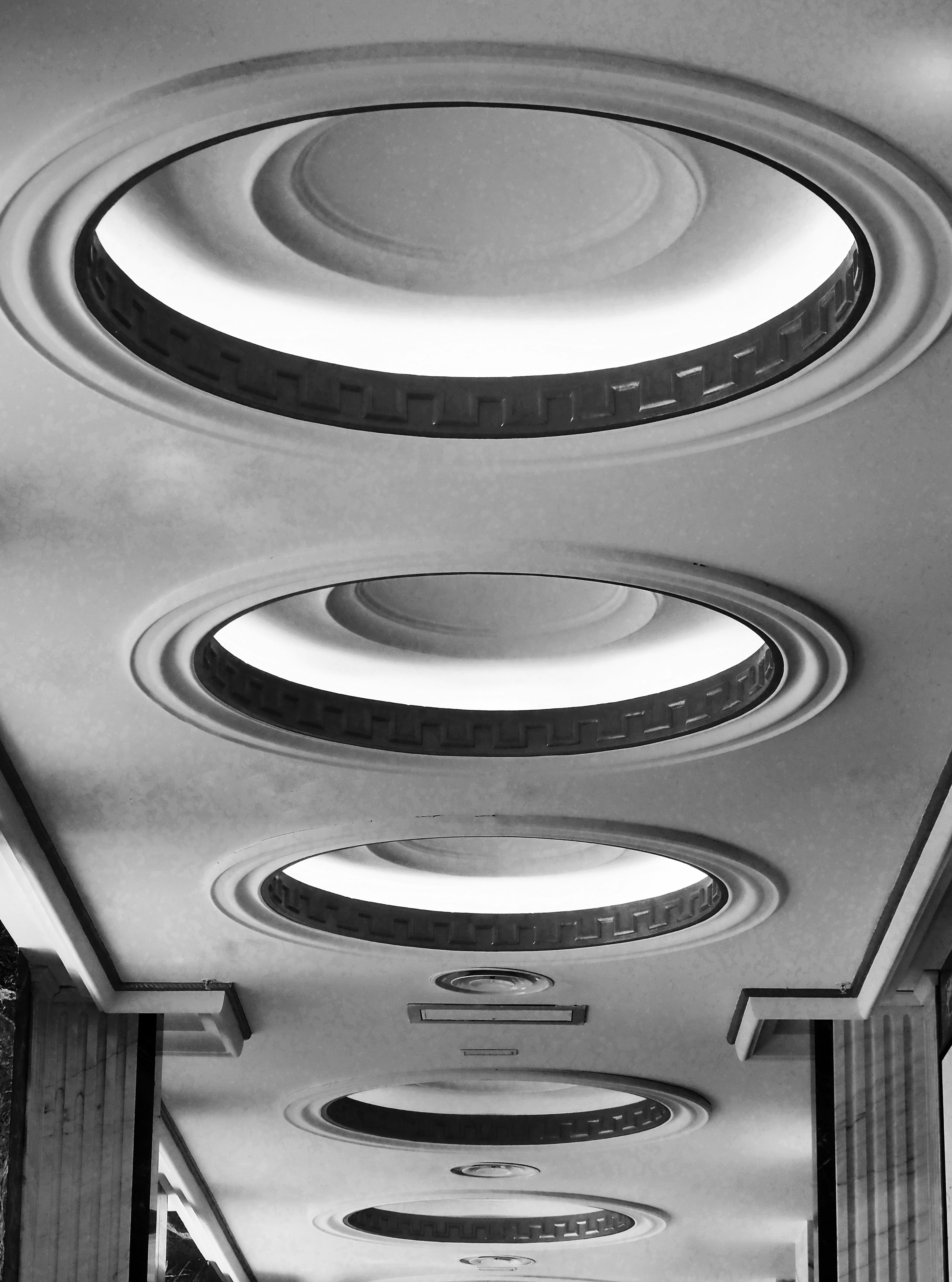 Circular Ceiling Vents: A Monochrome Corridor Study
