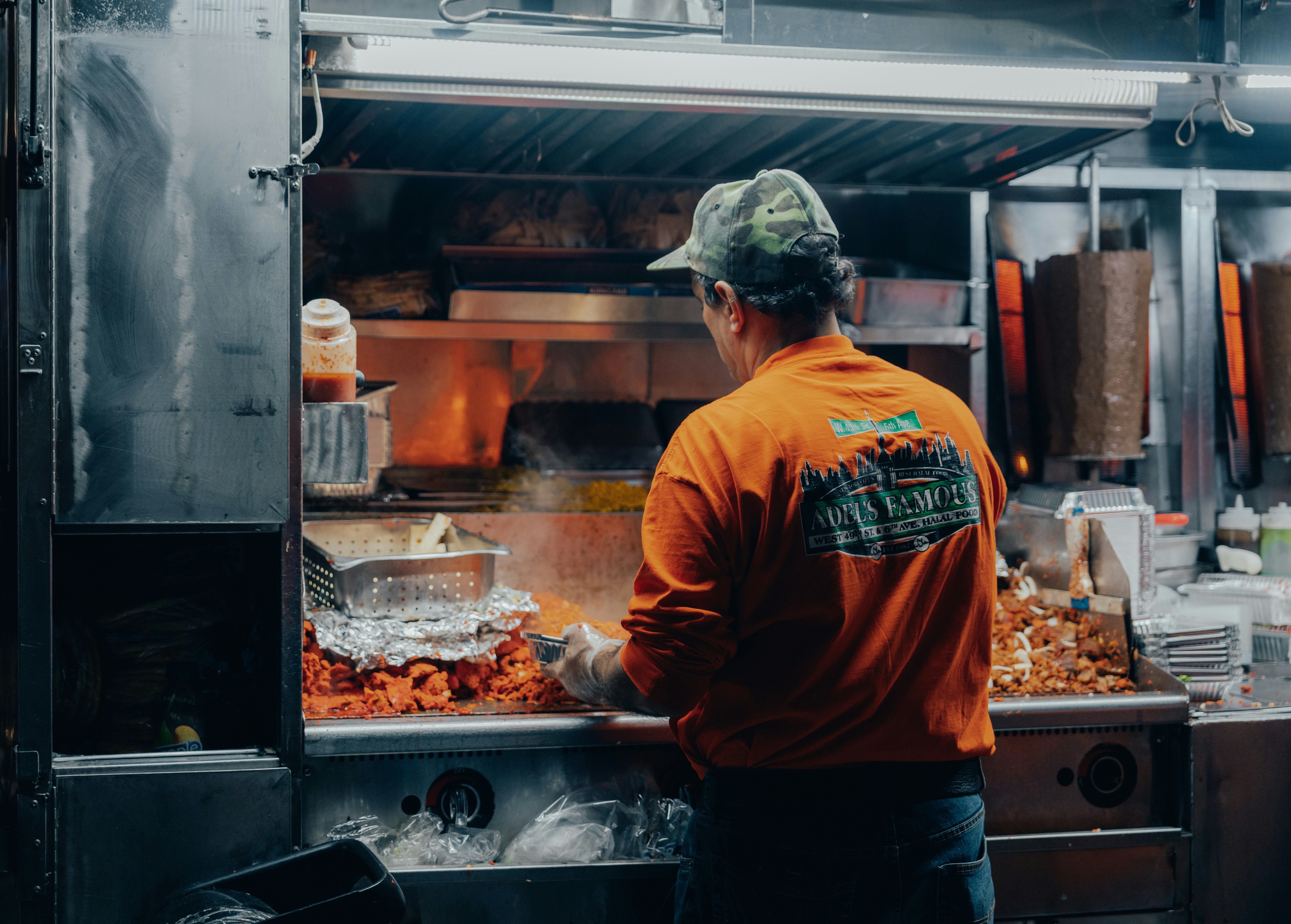 Backlit Grill Station: The Cook Behind the Chaos