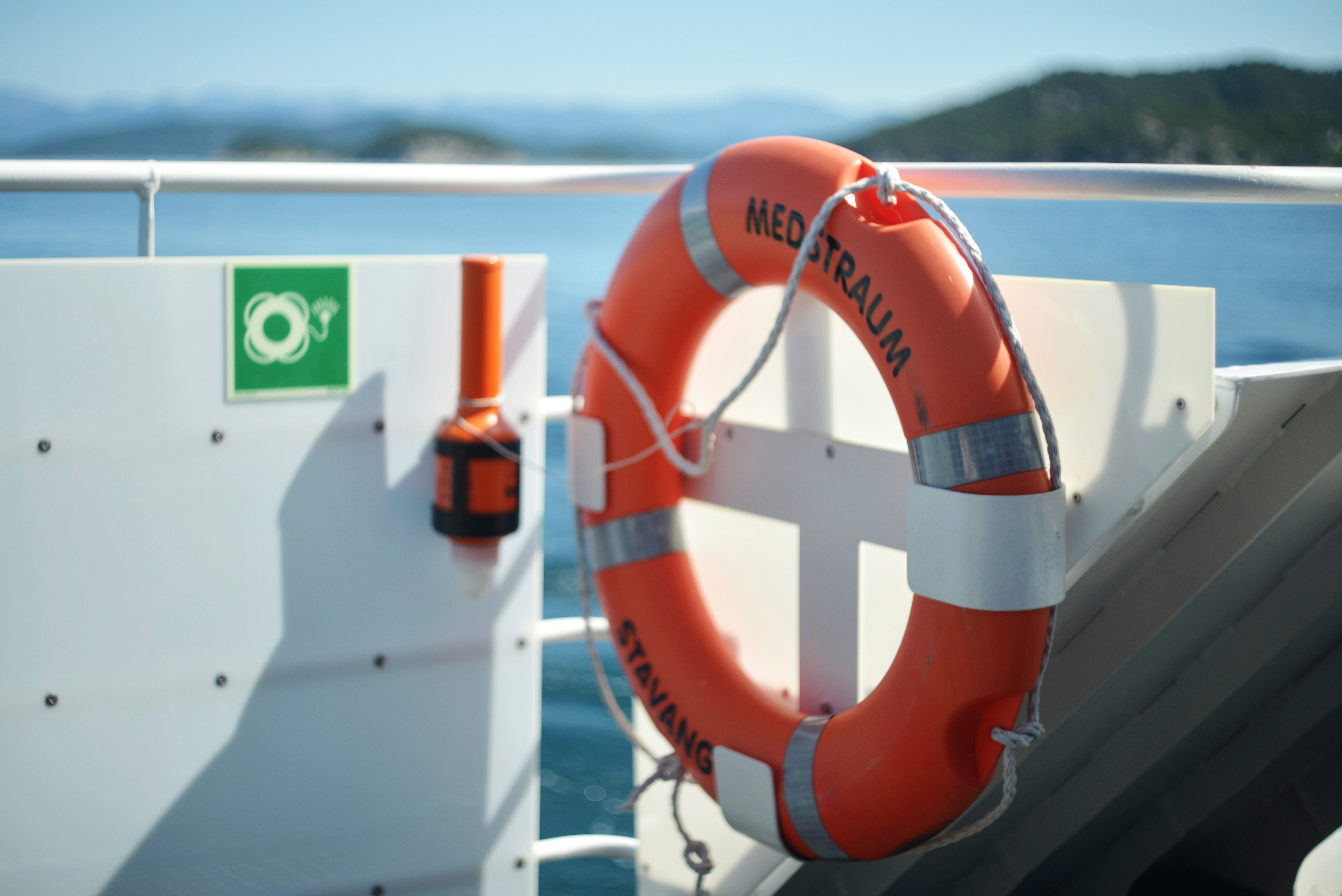 Orange Lifebuoy Grips the Scene by the Ocean Rail