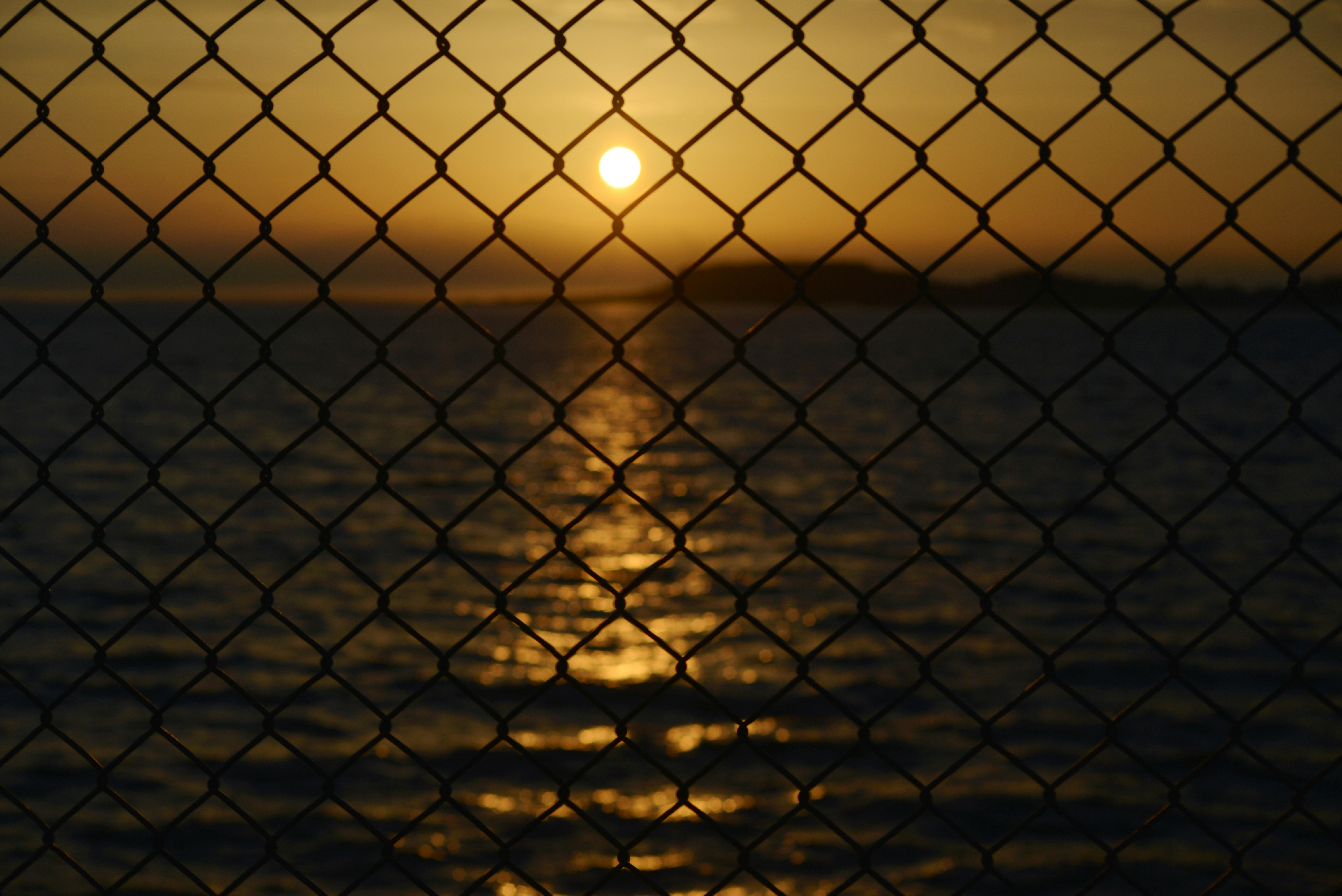 Sunlit Copper Chain: Sunset over a Distant Sea