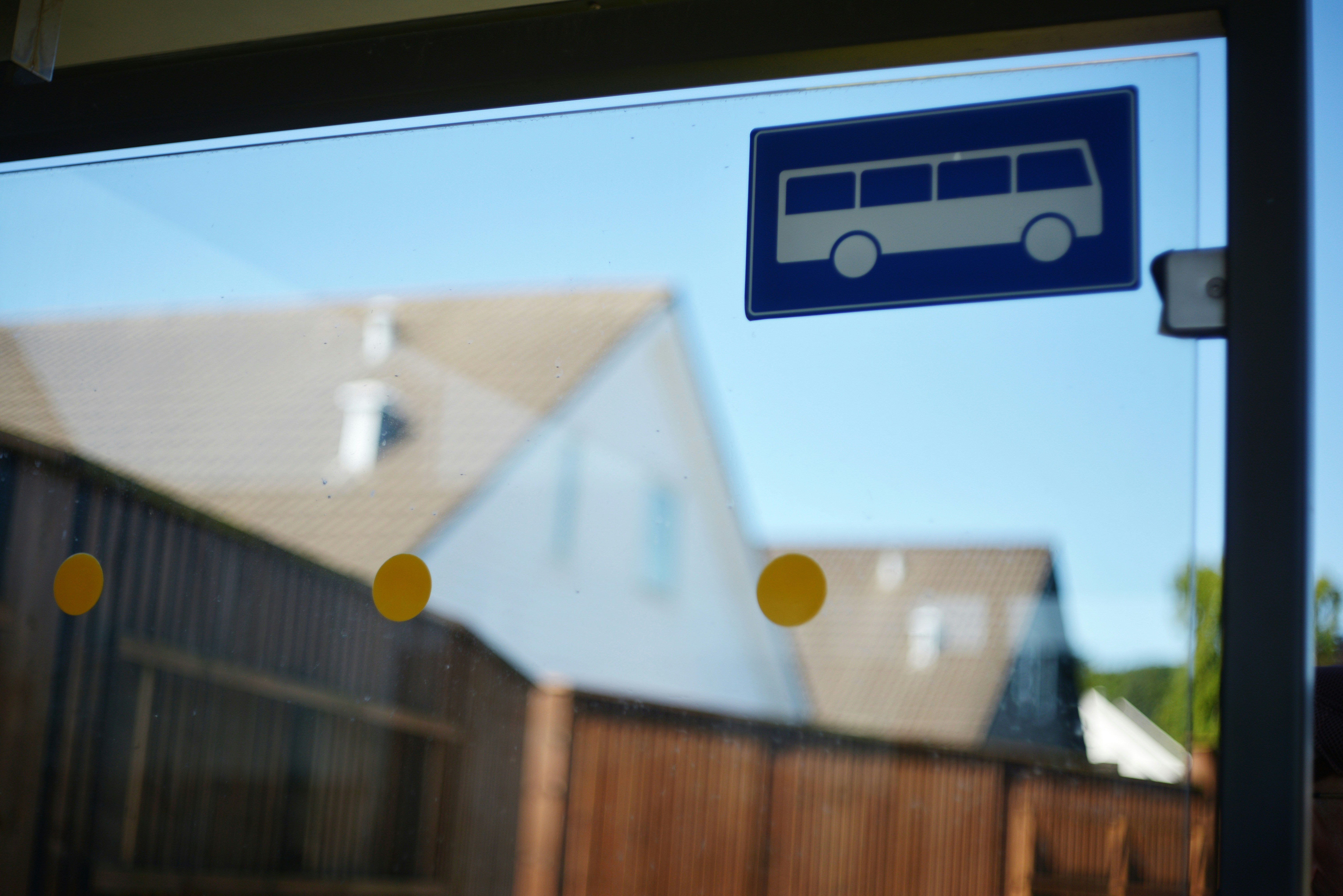 Bus Stop Window: A Quiet Suburban Moment Through Glass