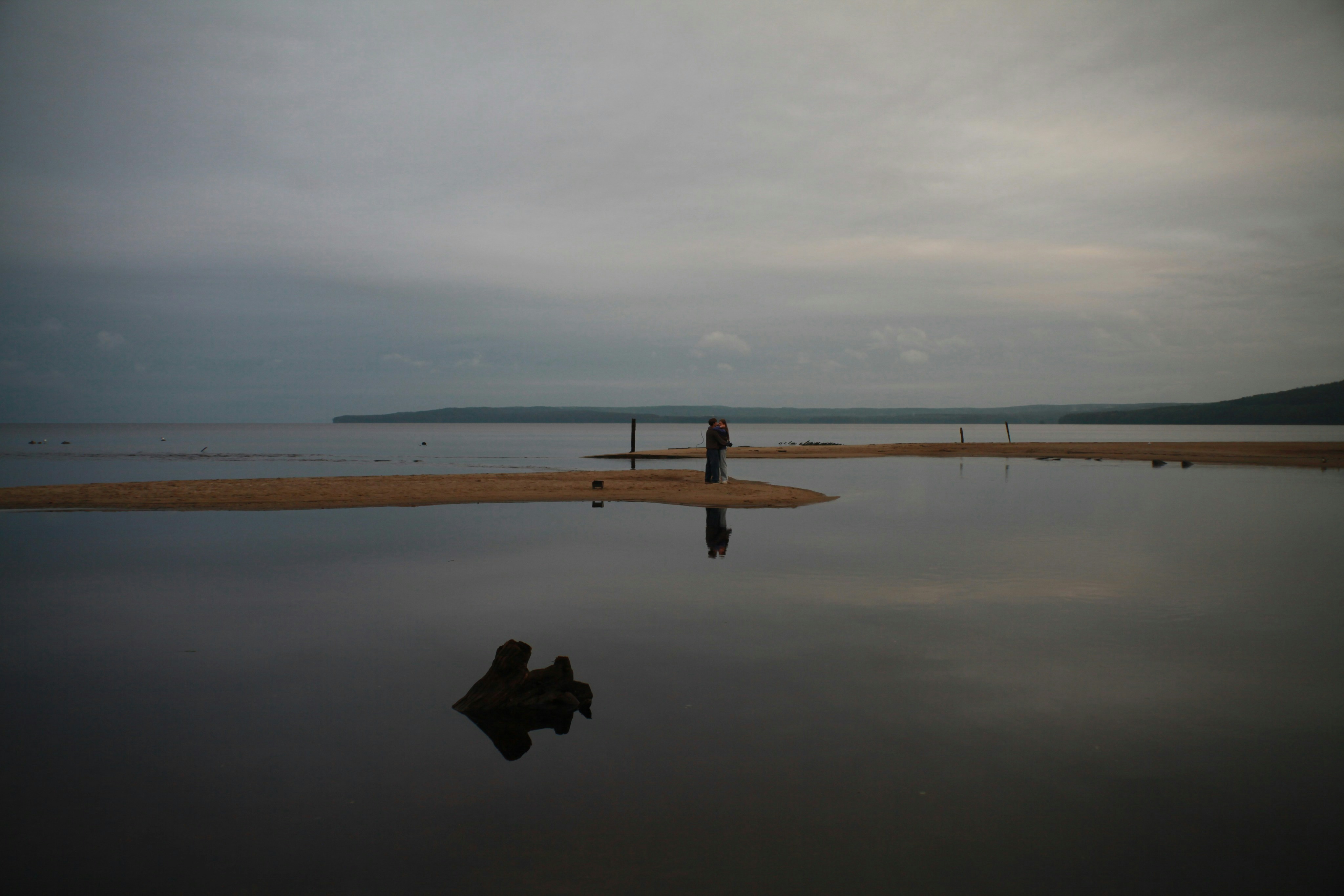 Solitary Figure at the Edge of a Quiet Lake