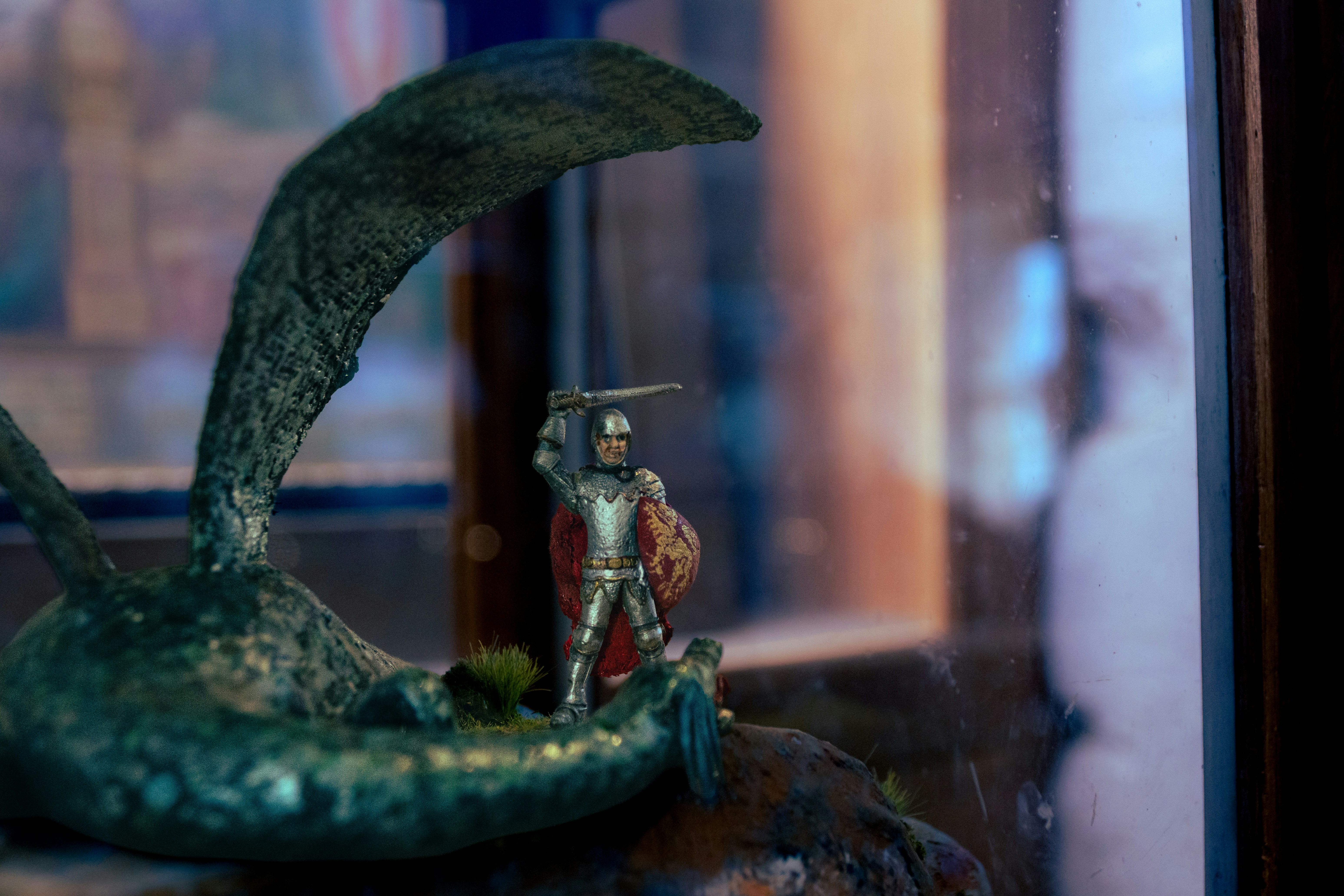 Knight in a bottle: a tiny armored figure guards a dusty harbor of blue-green relics