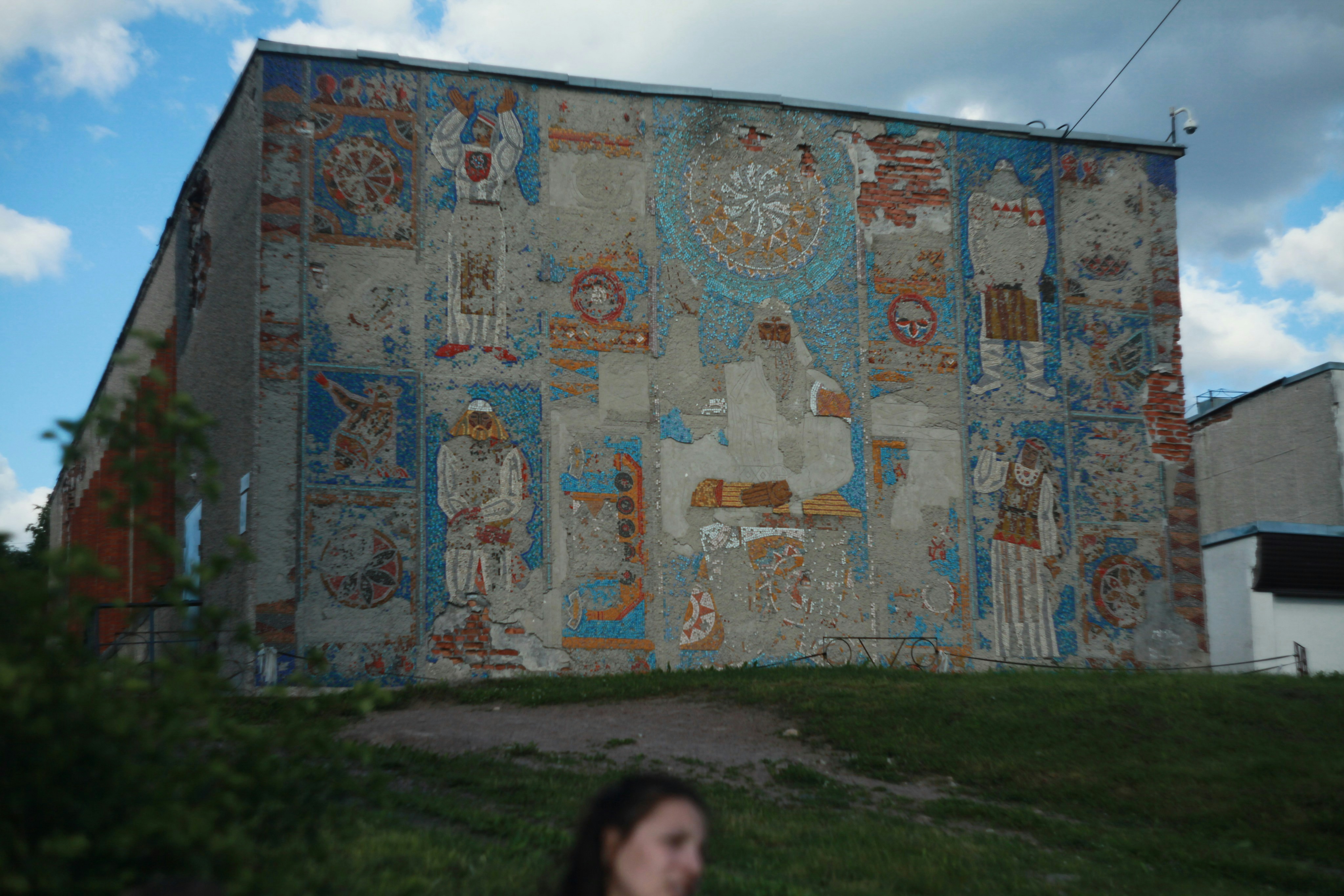 Mural of Forgotten Saints: A Facade of Faded Frescoes