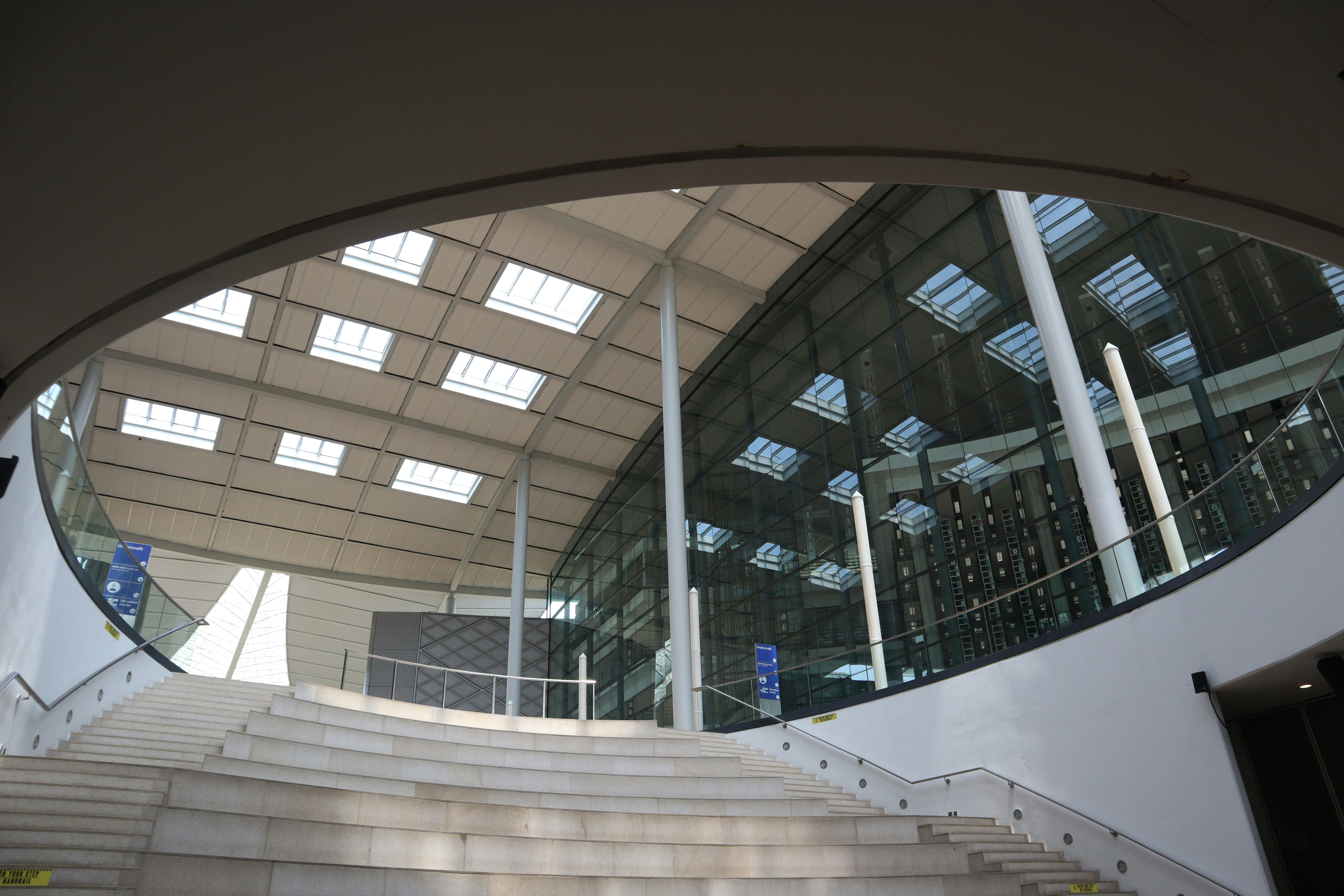 Curved Atrium Echoes with Staircase Echoing the Sky