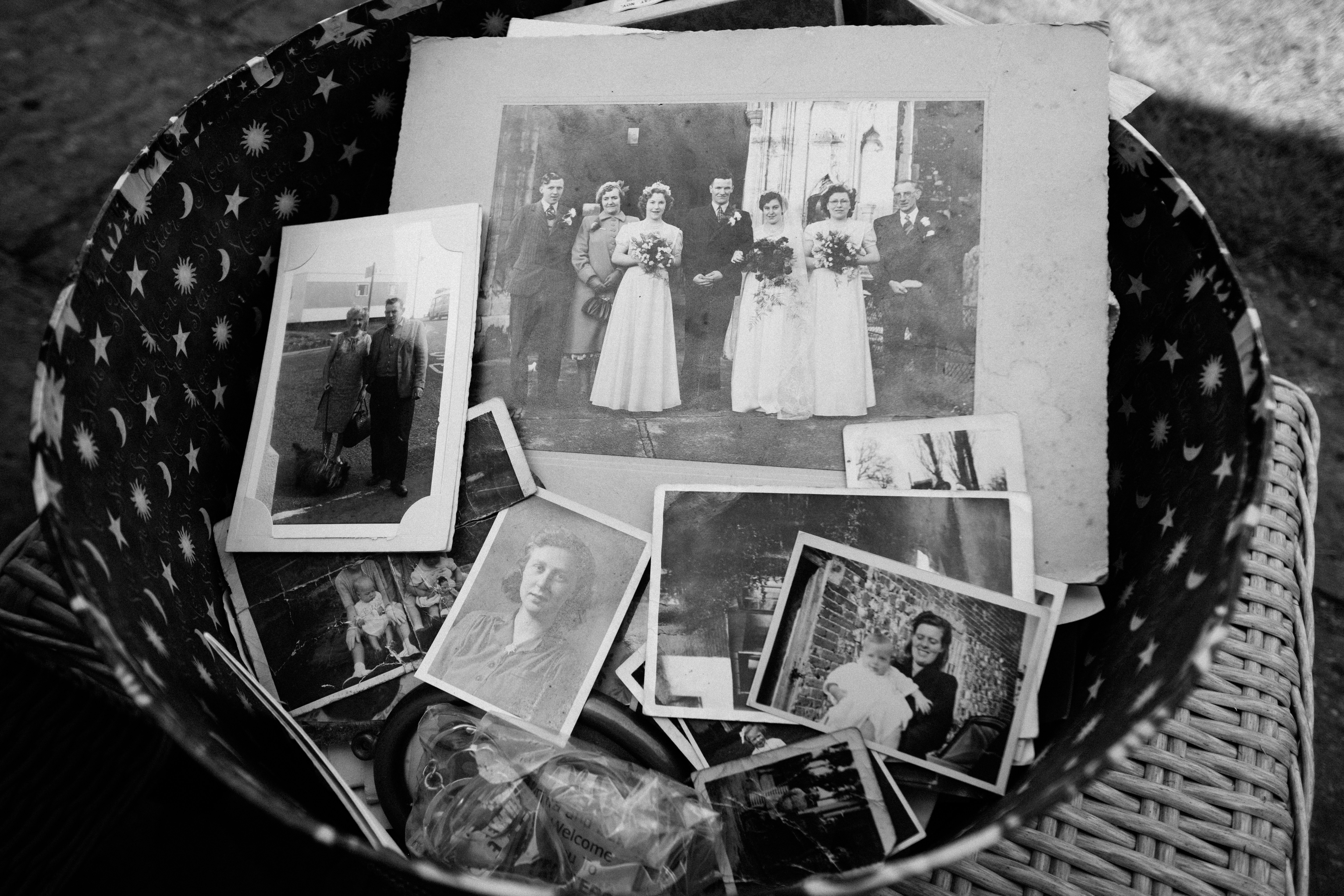 Whispers of Memory: A Basket Brimming with Timeworn Portraits