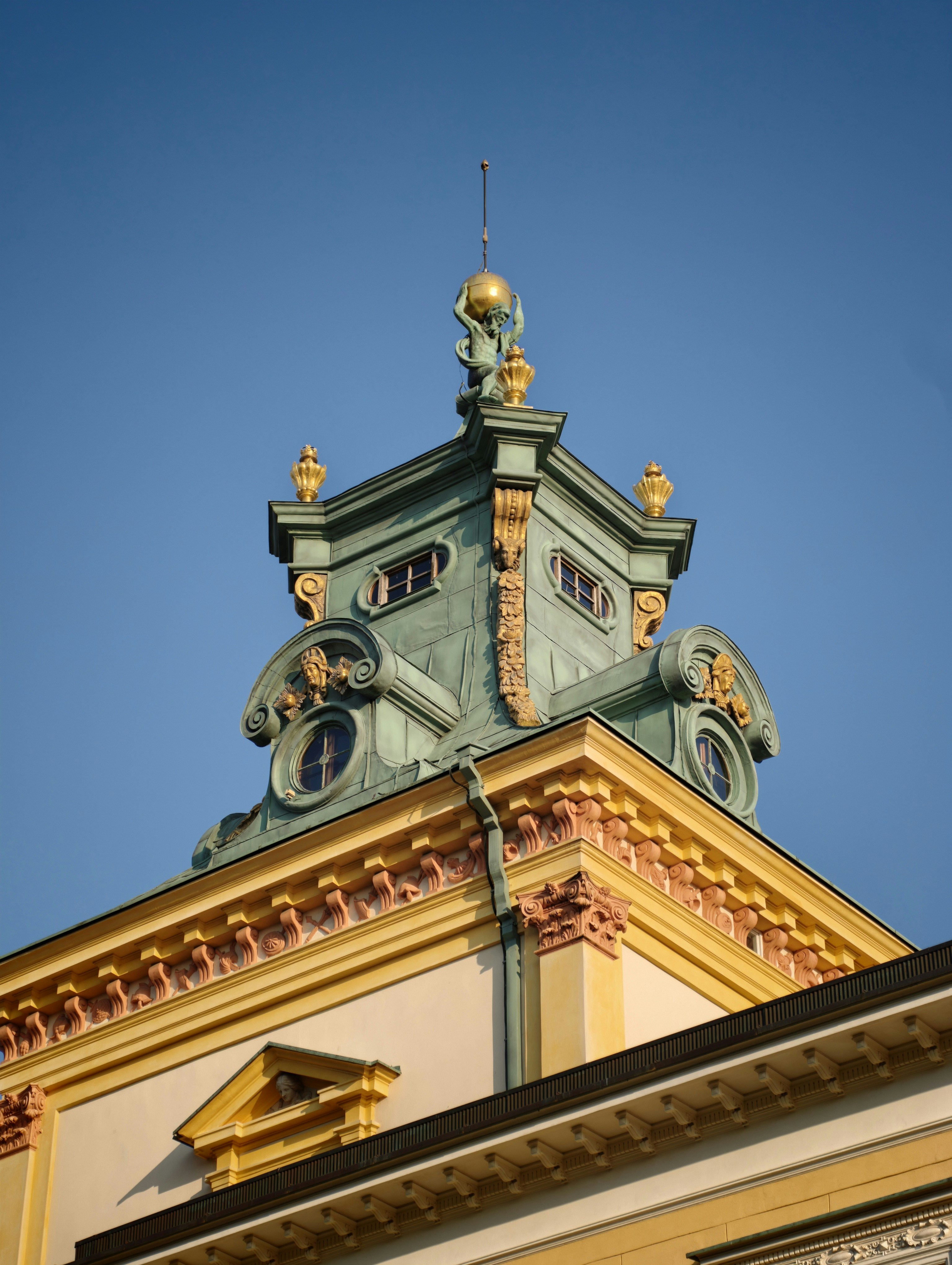 Gold-tinged rooftop ornament crowned by a blue sky
