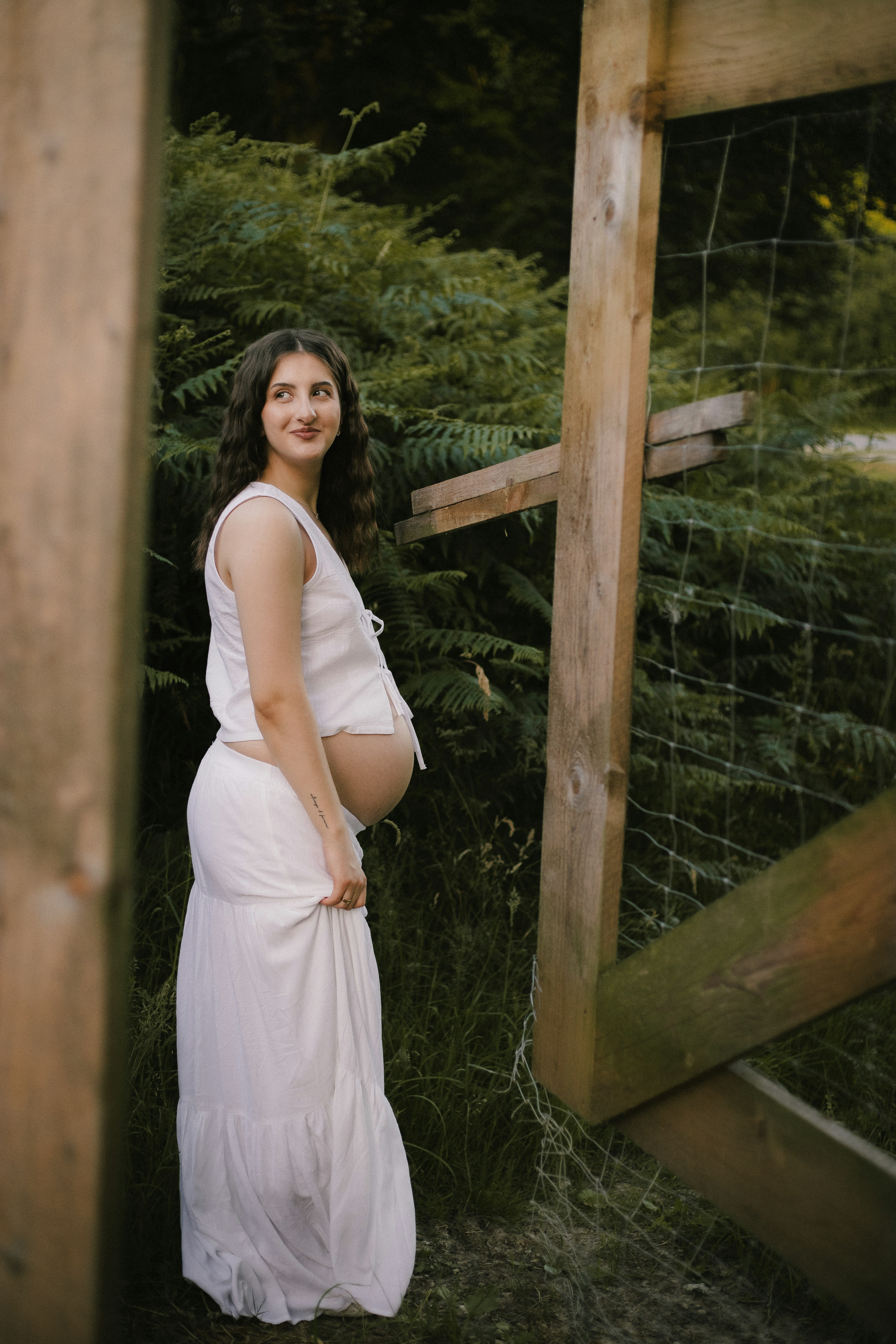 Pregnant Silence: A Portrait Beneath Timber and Foliage