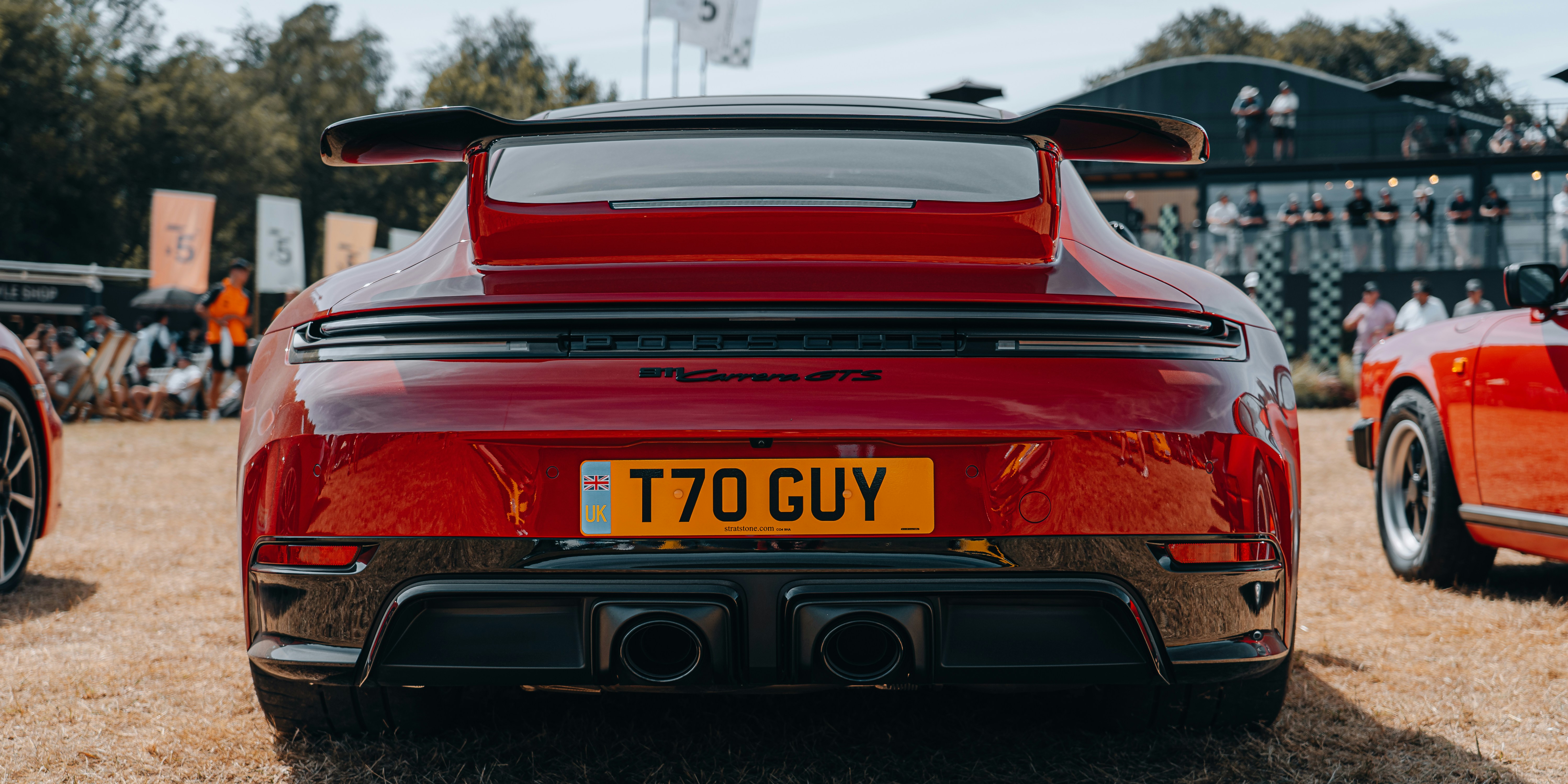 Rear View of a Red Porsche 911 GT3 in a crowded outdoor gathering