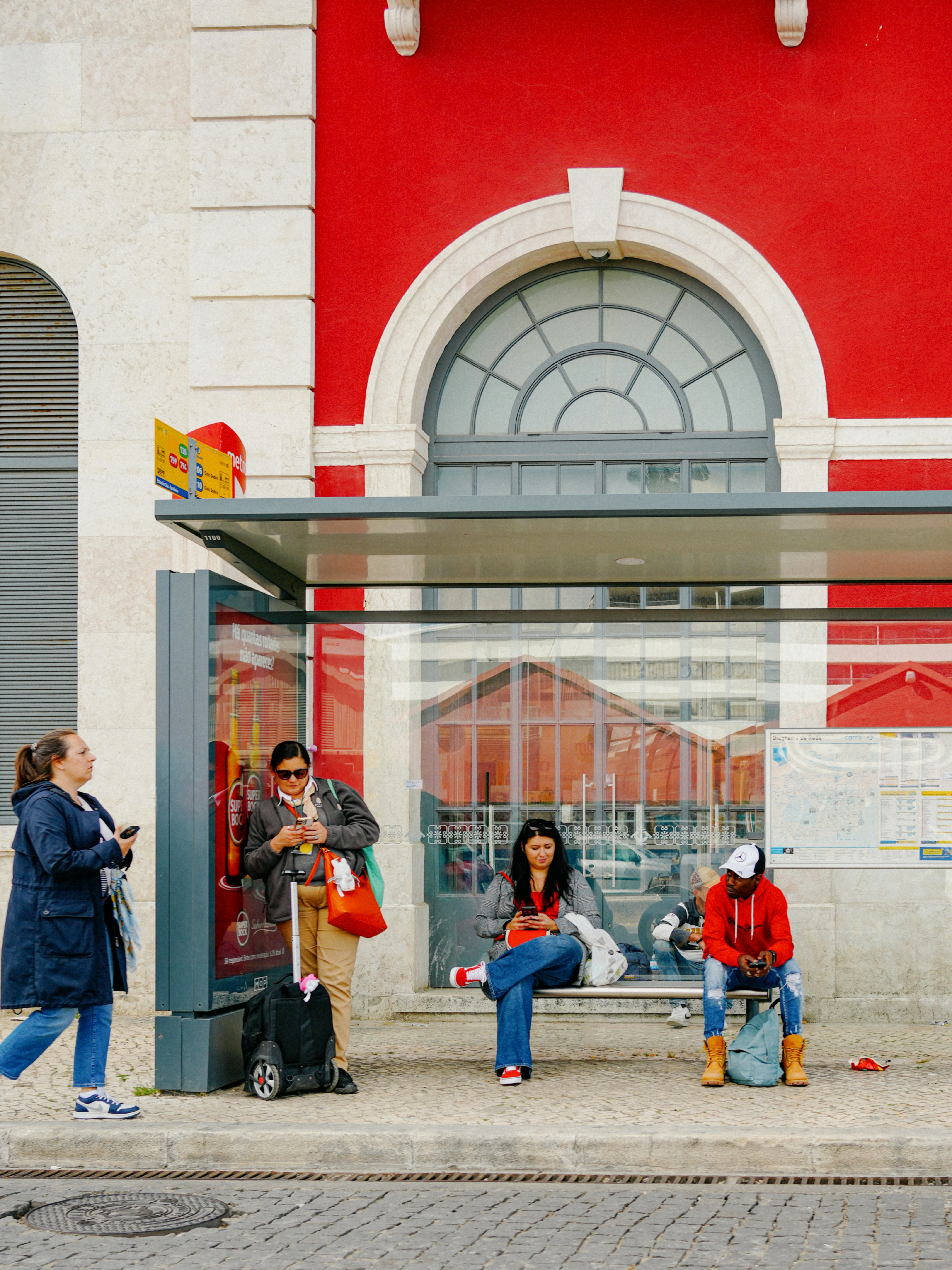Street Shelter: Moments at a Red-Walled Bus Stop