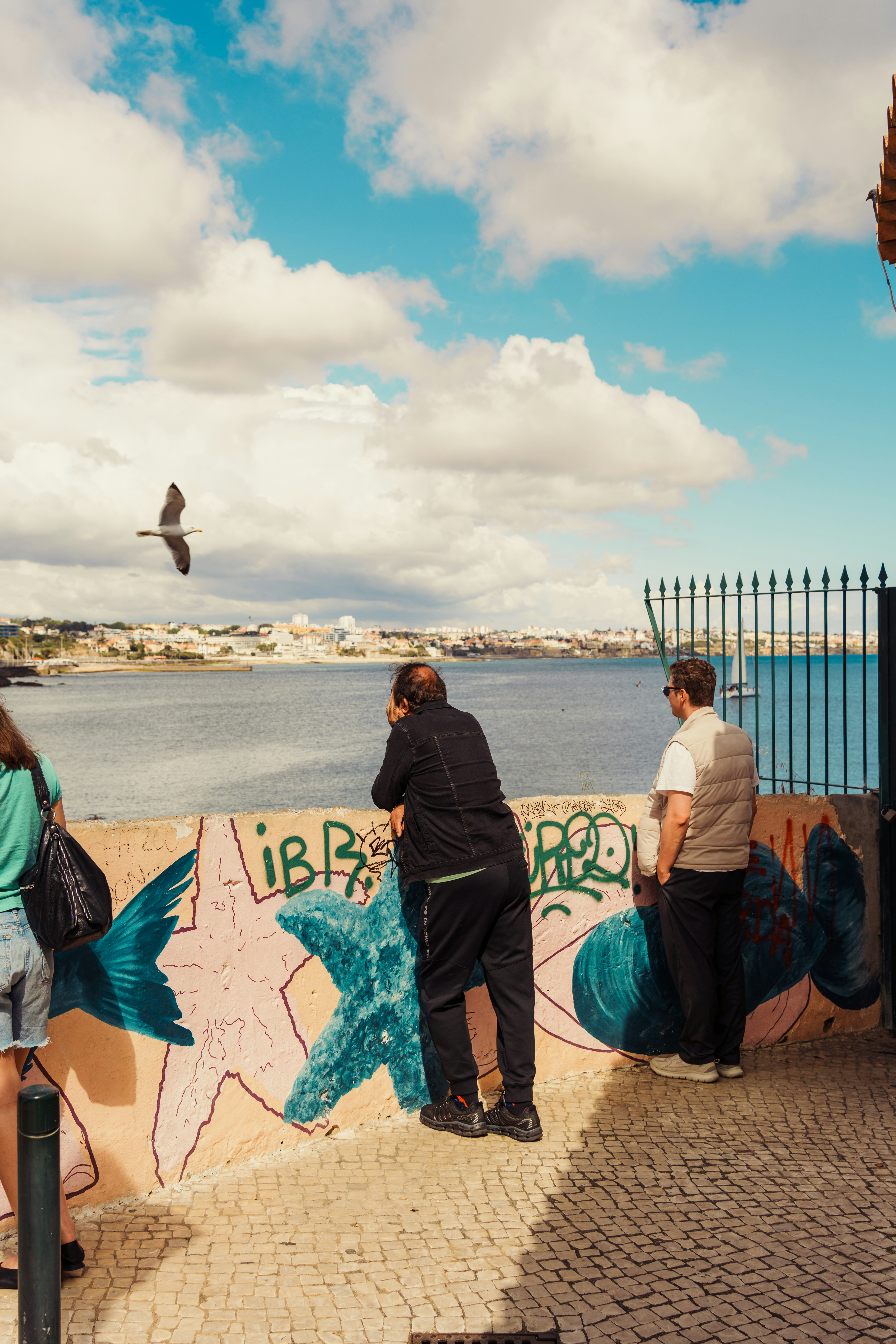 Seaside Conversation: A Moment at the Graffiti Wall