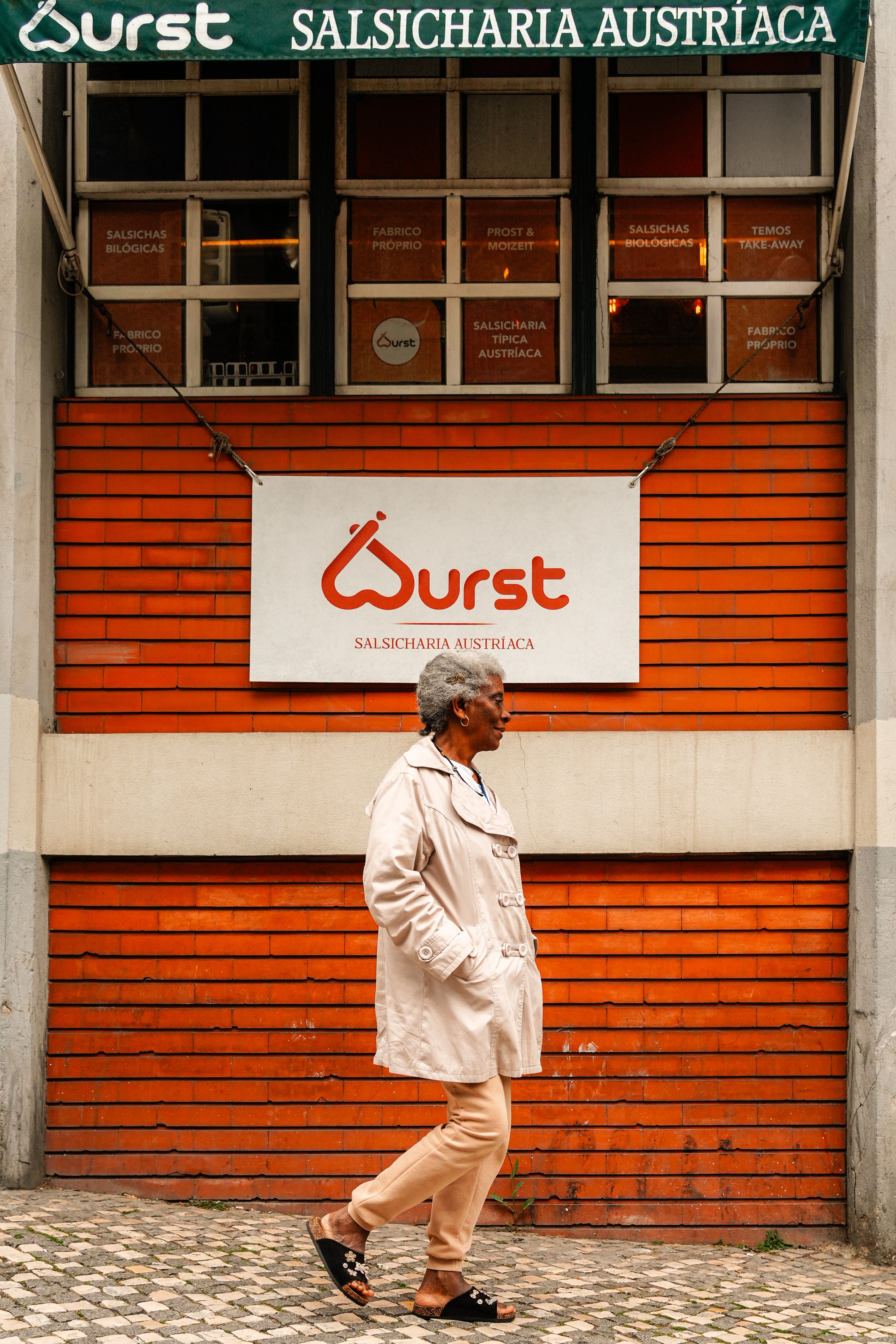 A Quiet Stride Past a Bold Sign