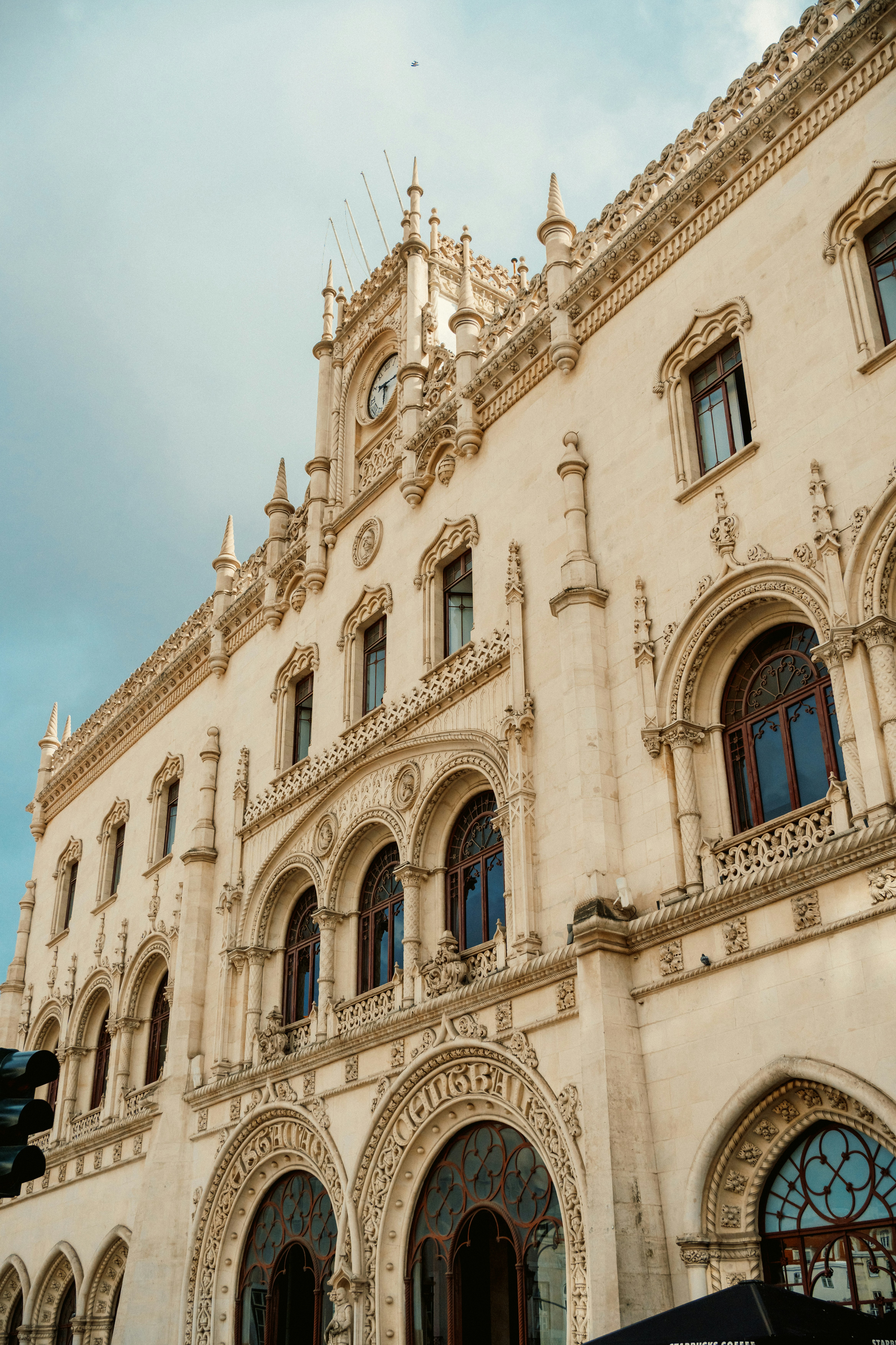 Ornate Facade Rising: Carved Stone and Arched Windows of a Historic Building