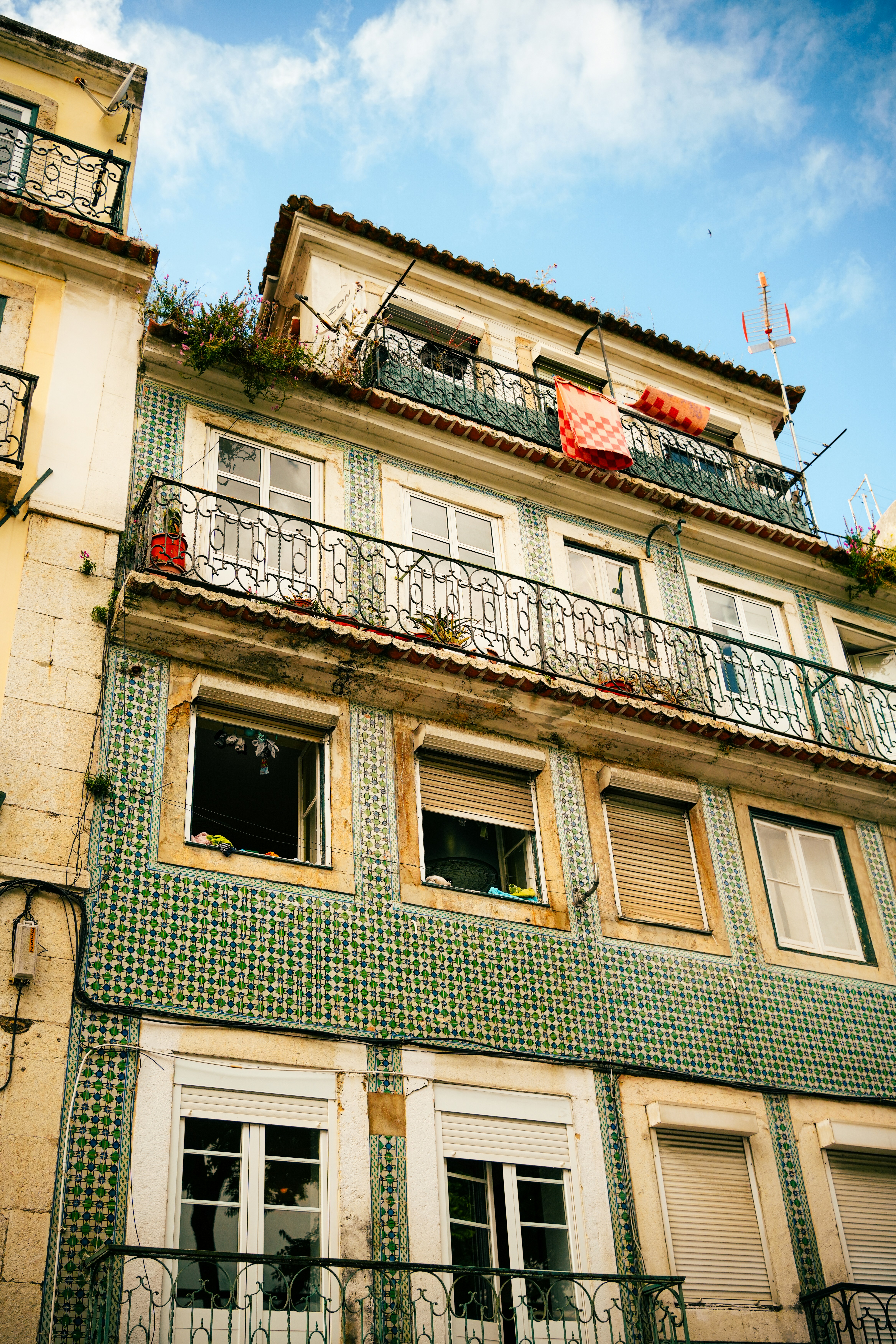 Terraced Facade Serenade: Tiles, Rails, and Laundry Lines