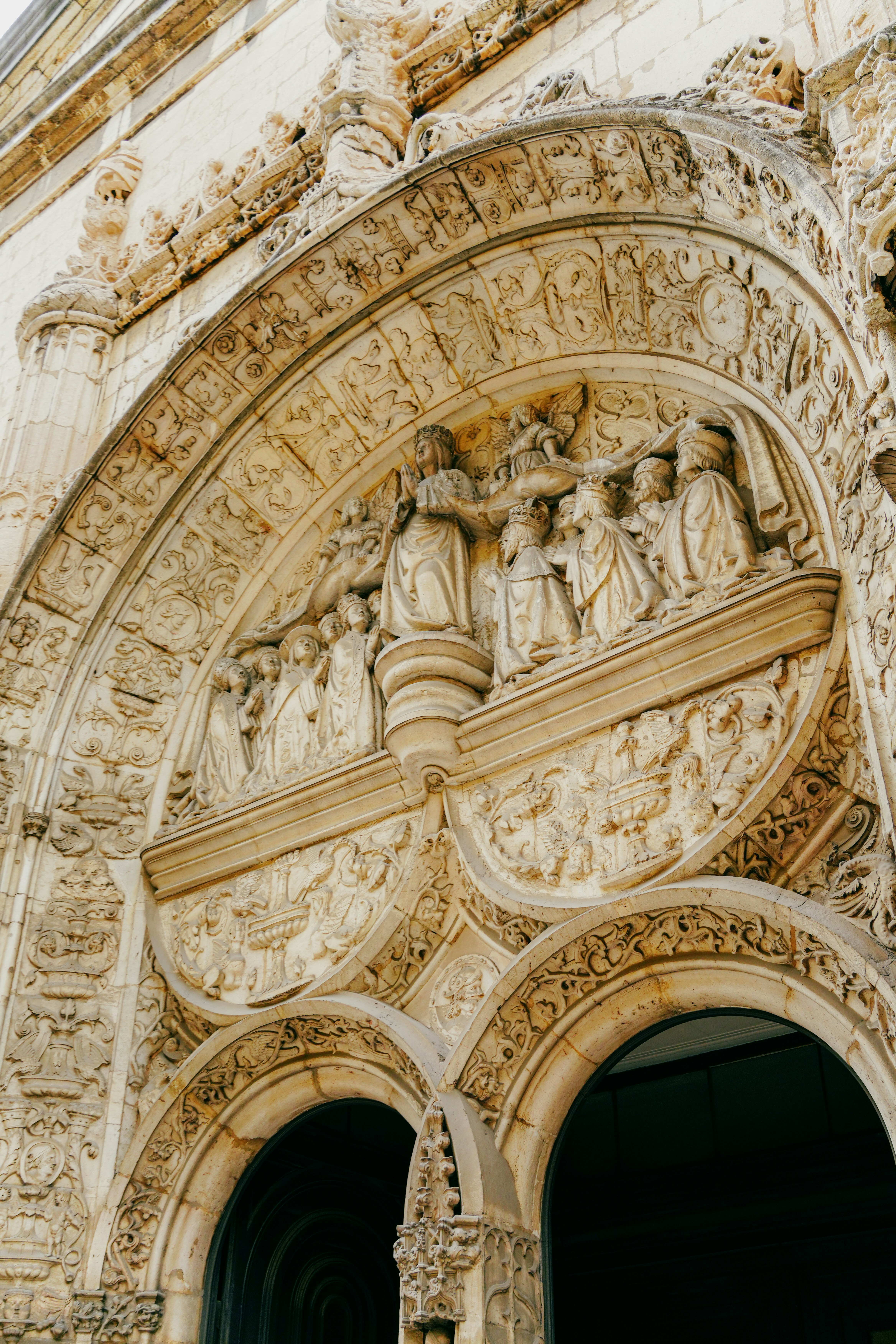 Carved Tympanum of a Cathedral: Stone Figures in Golden Light